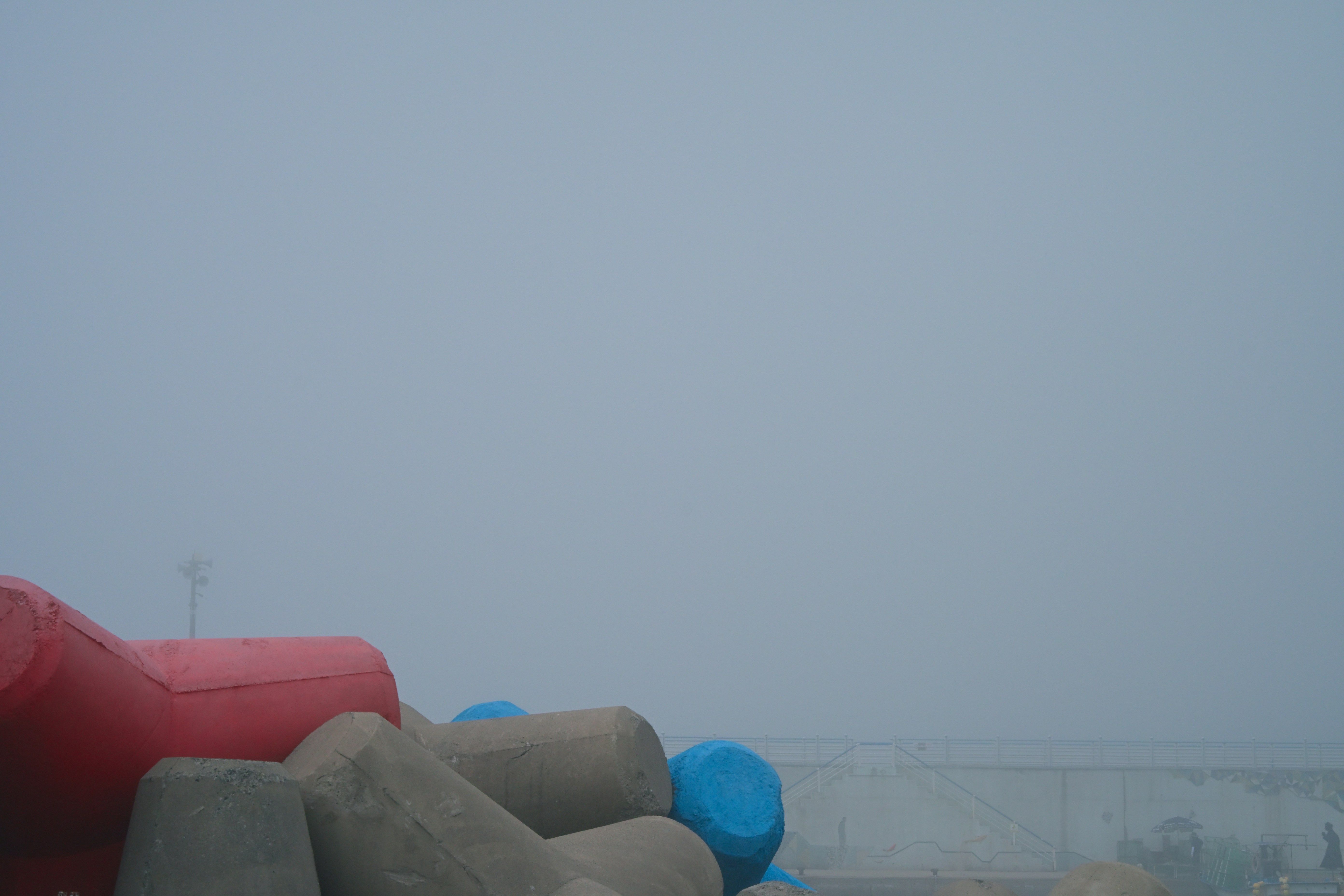 Coastal Breakwater with Piled Tetrapods under Misty Sky