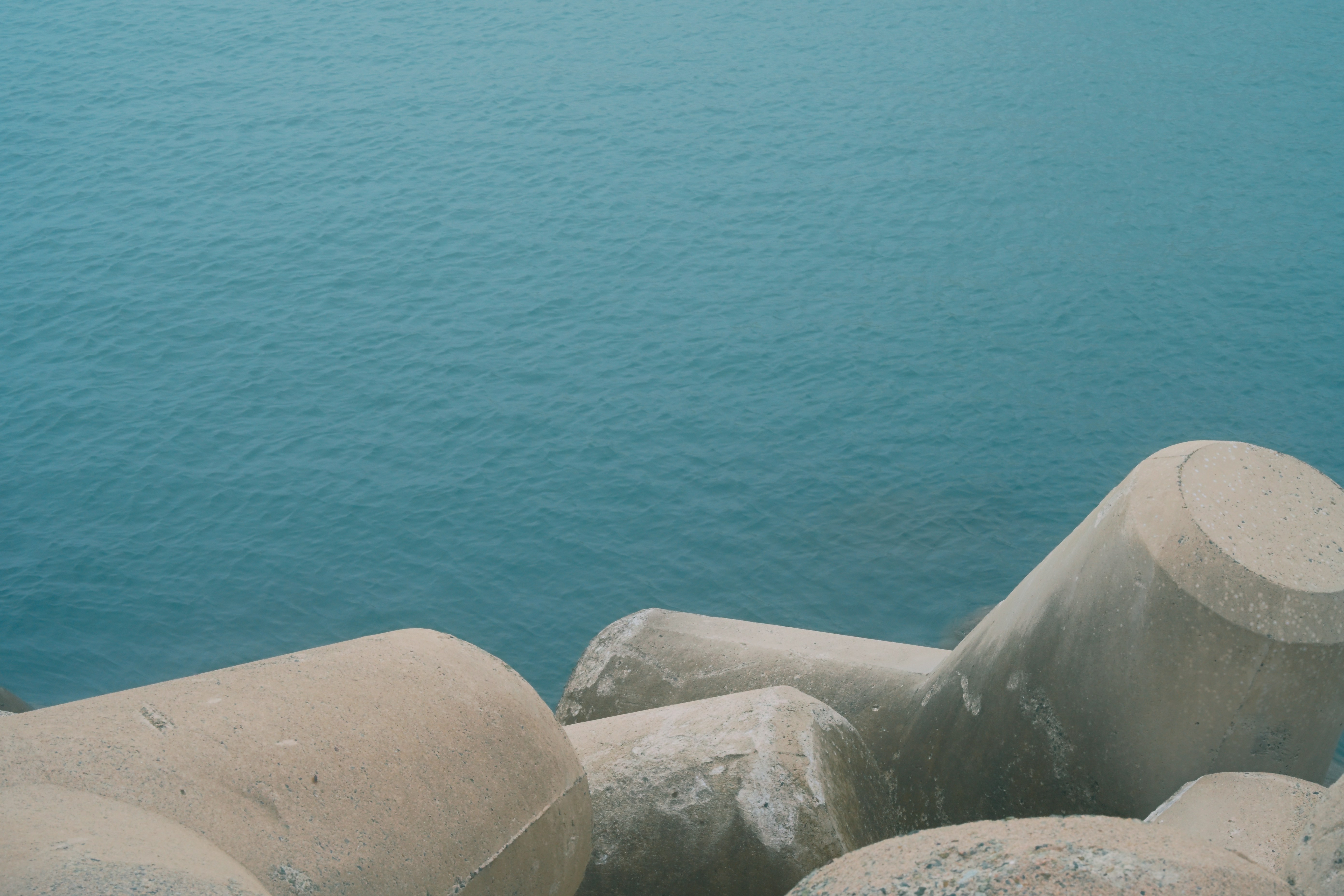Harbor Breakwaters Meet the Calm Blue Expanse