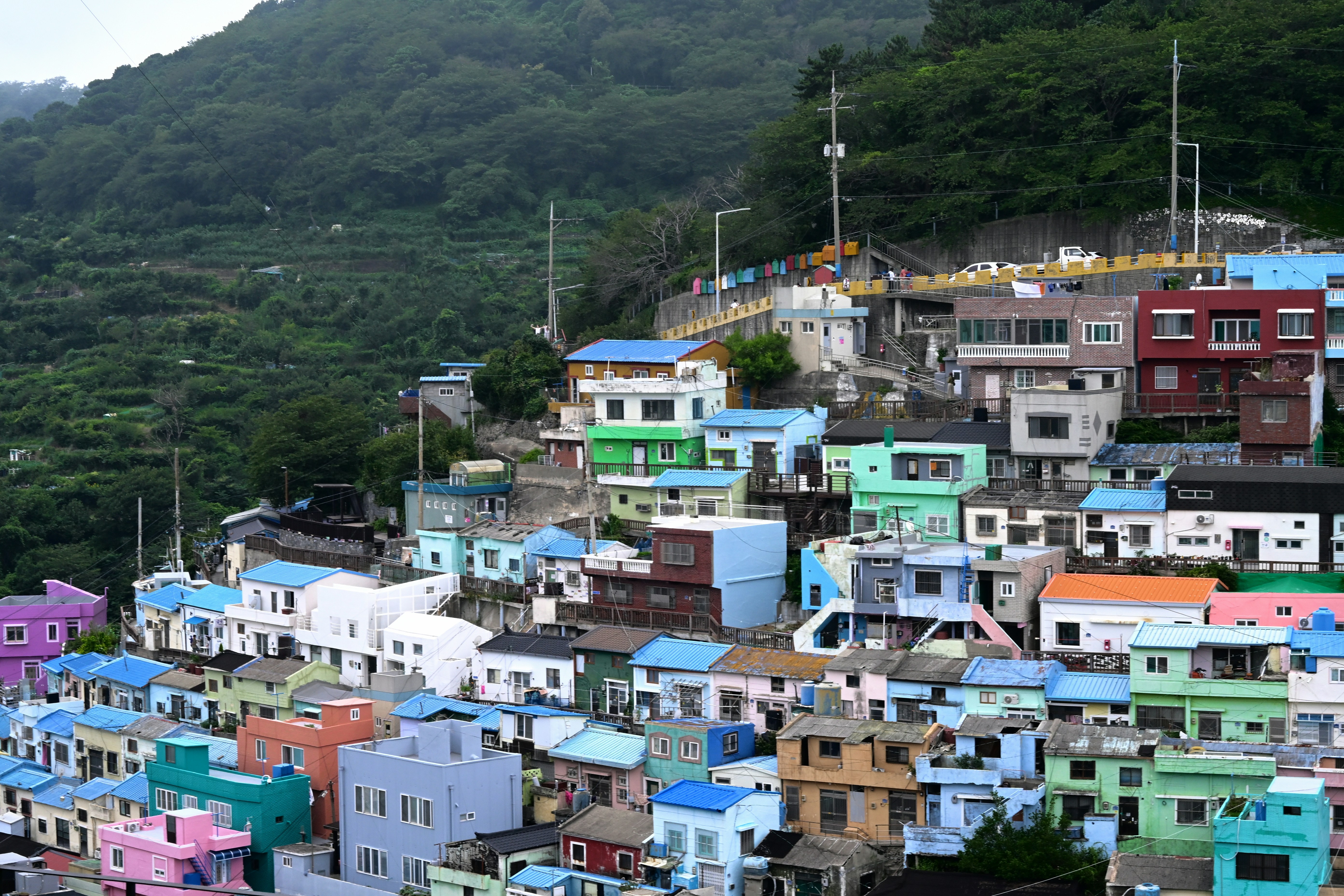 Colorful hillside village clusters on a terraced slope