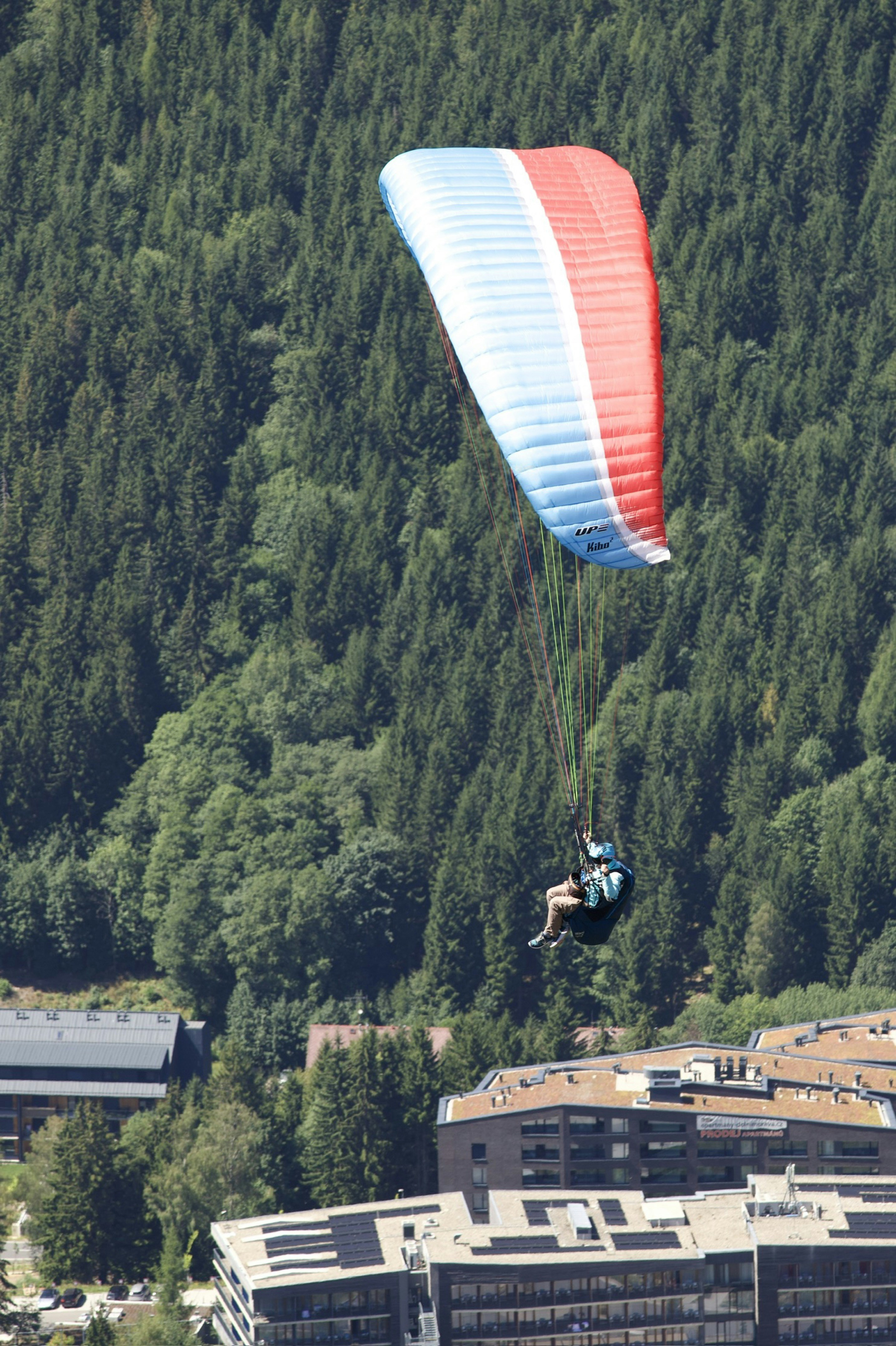 Airborne Acrobat Over the City: A Paragliding Moment