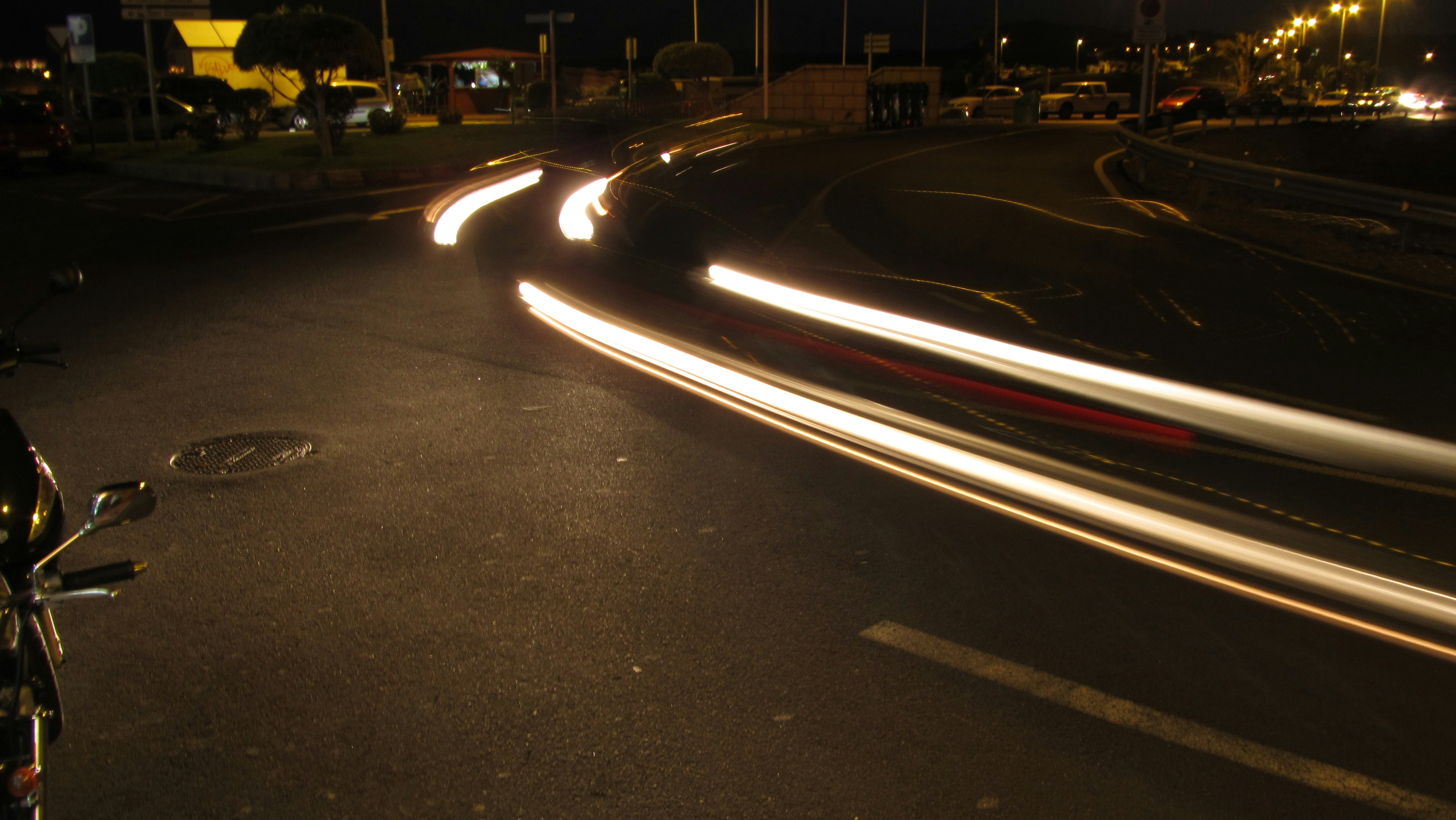 Nighttime Car Cavern: Light Trails Through a Paved Roundabout