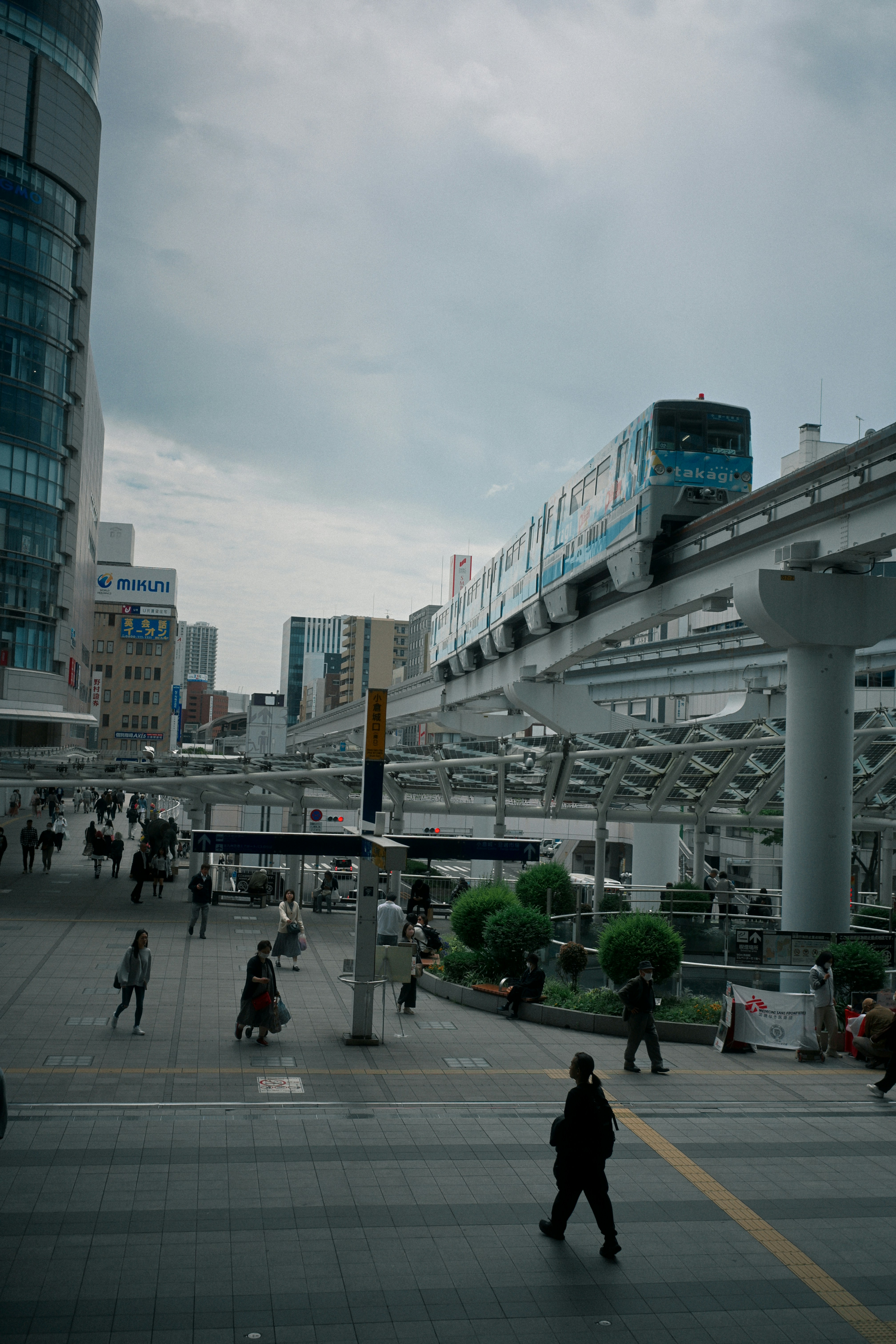 Urban Transit Overlook: People and Skytrain in a Modern Plaza