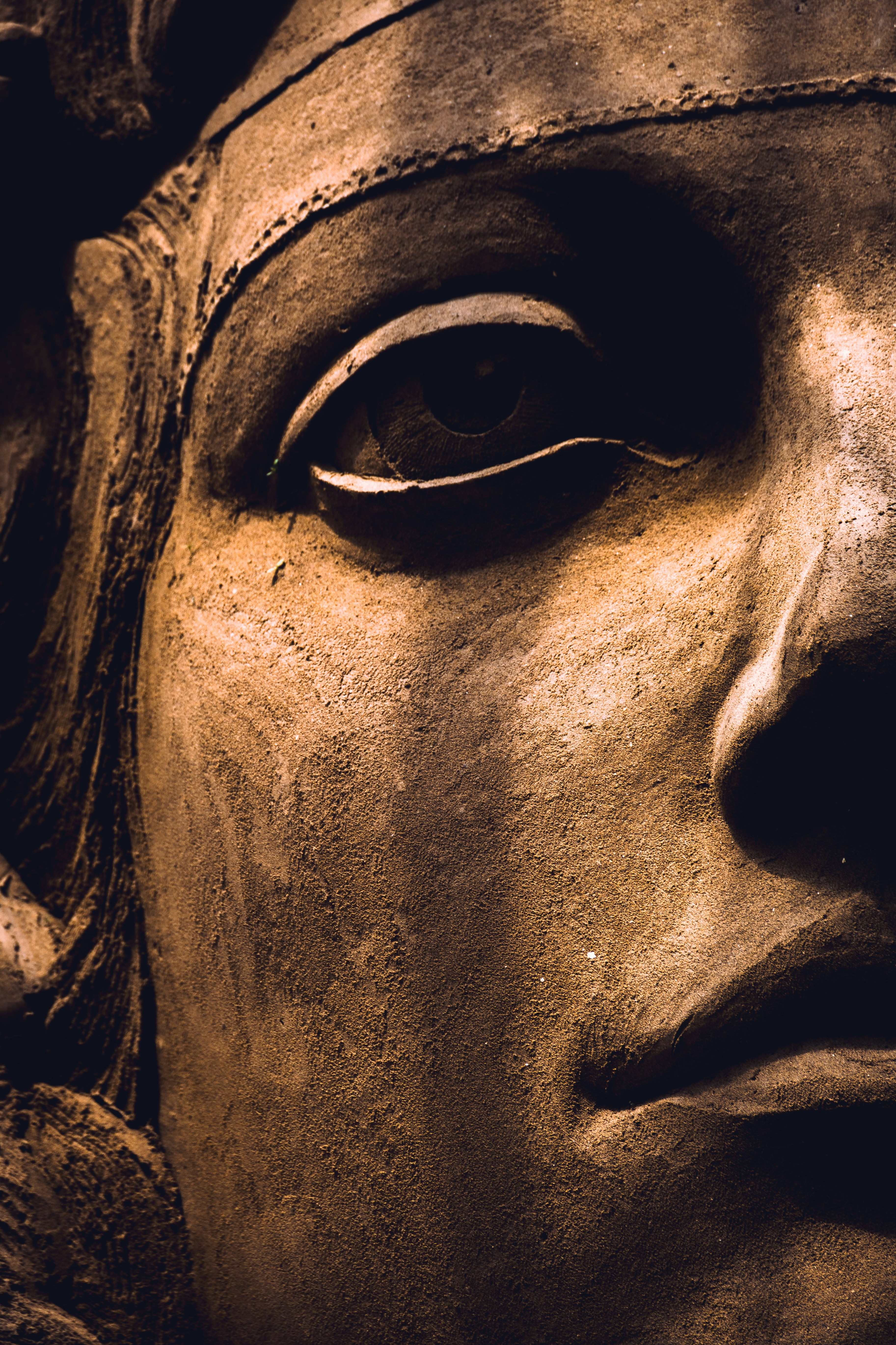 Half a Gaze: Close-Up of Weathered Stone Carving