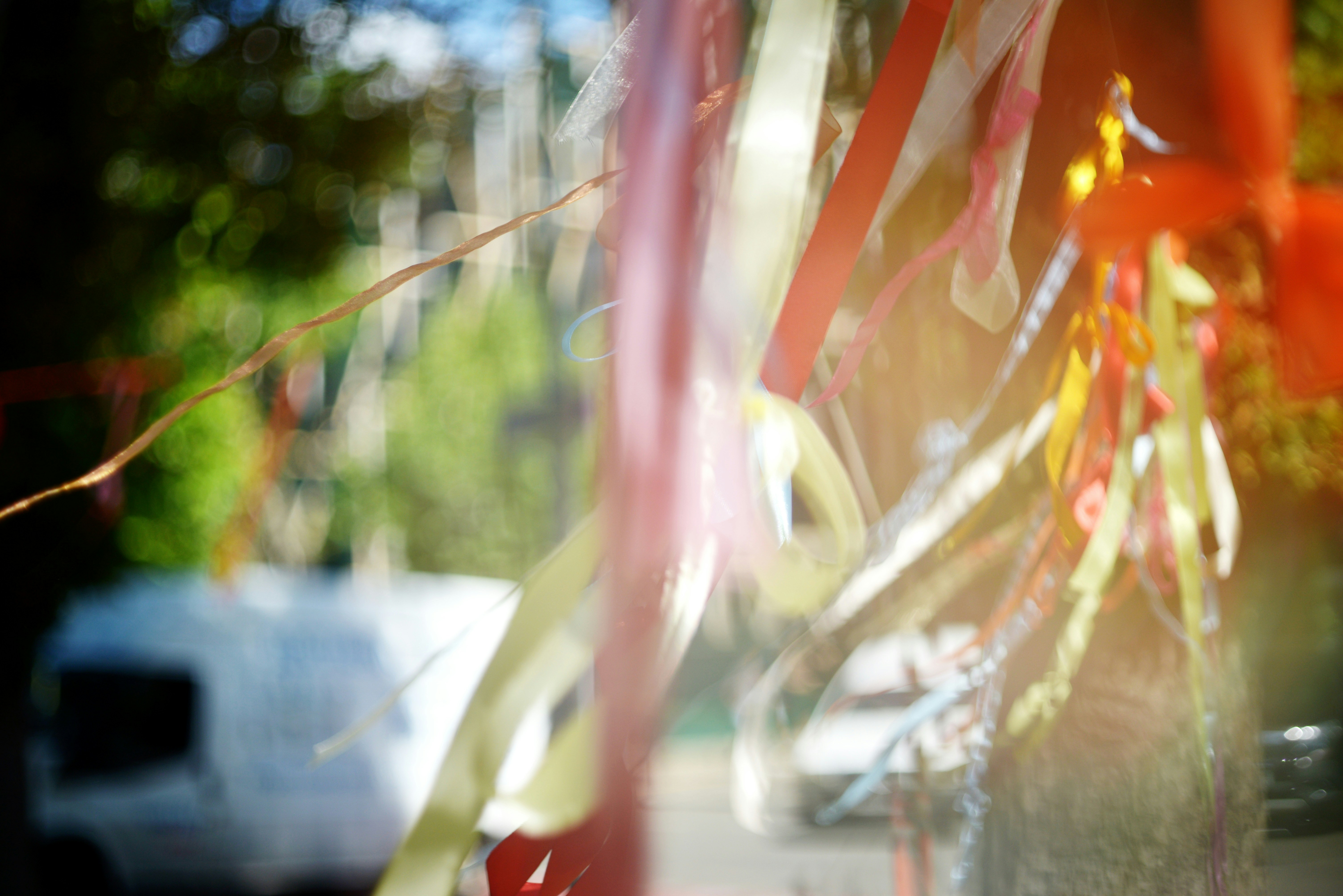 Ribbons in the Sunlit Street: Colorful Threads Blurring into Light
