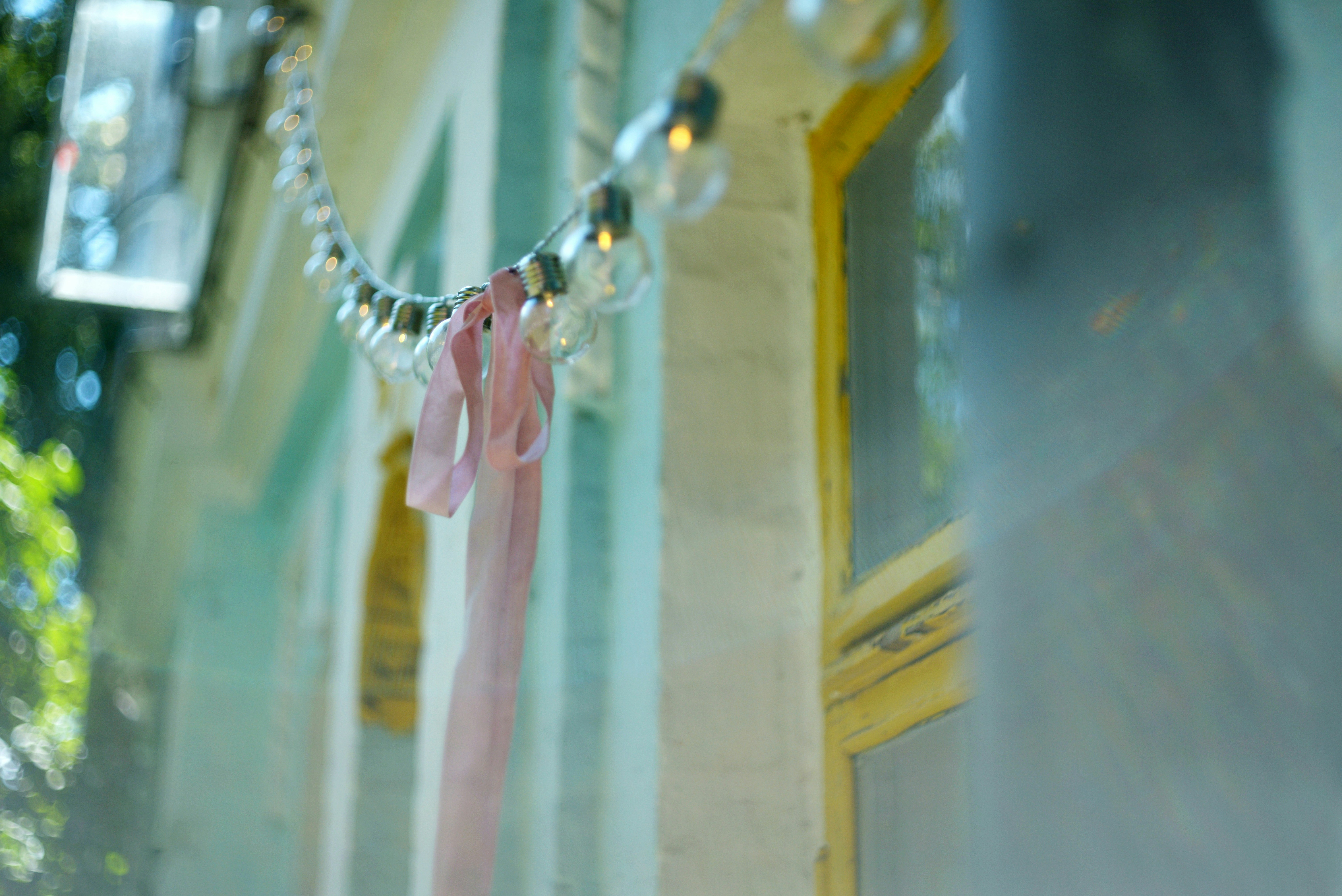 Ribbon and Light: A Quiet Moment on a Sunlit Facade