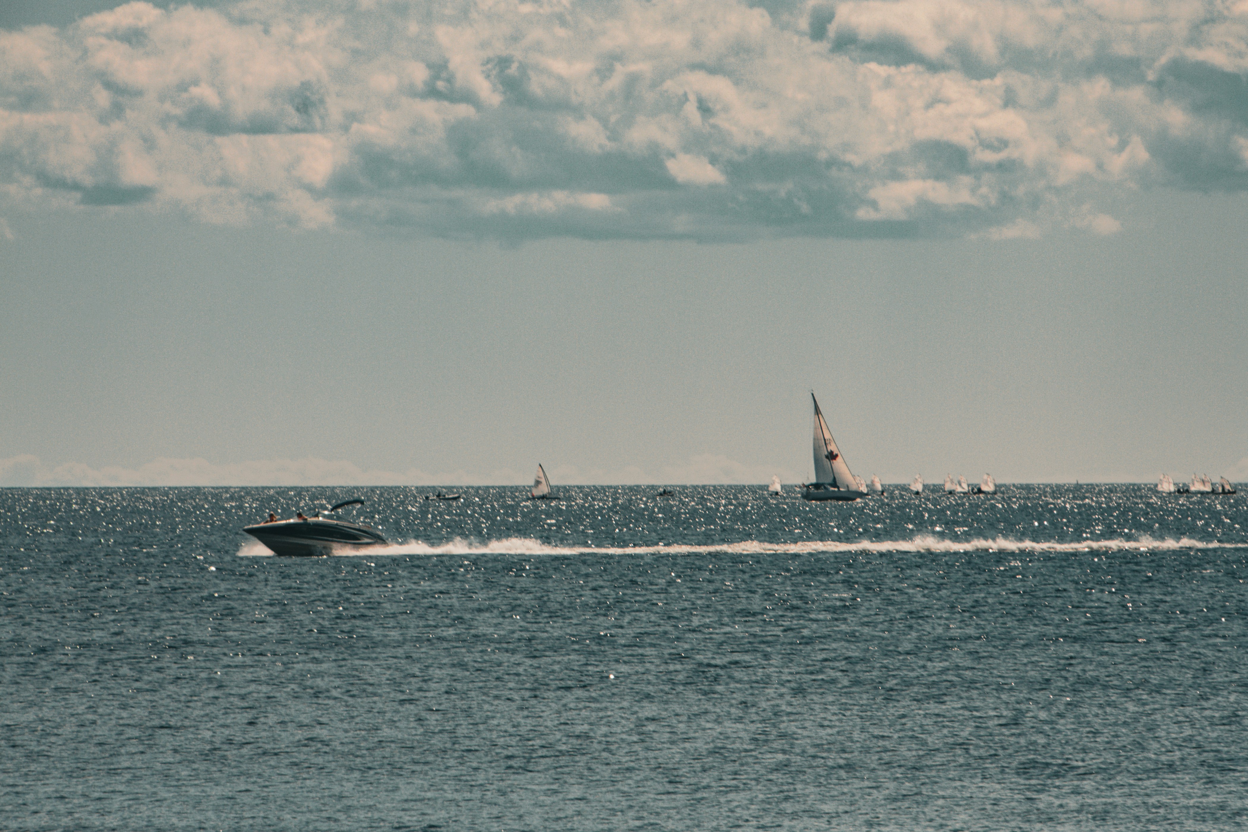 White-speedboat Slice: A Glimpse of Maritime Motion Across a Dim Ocean