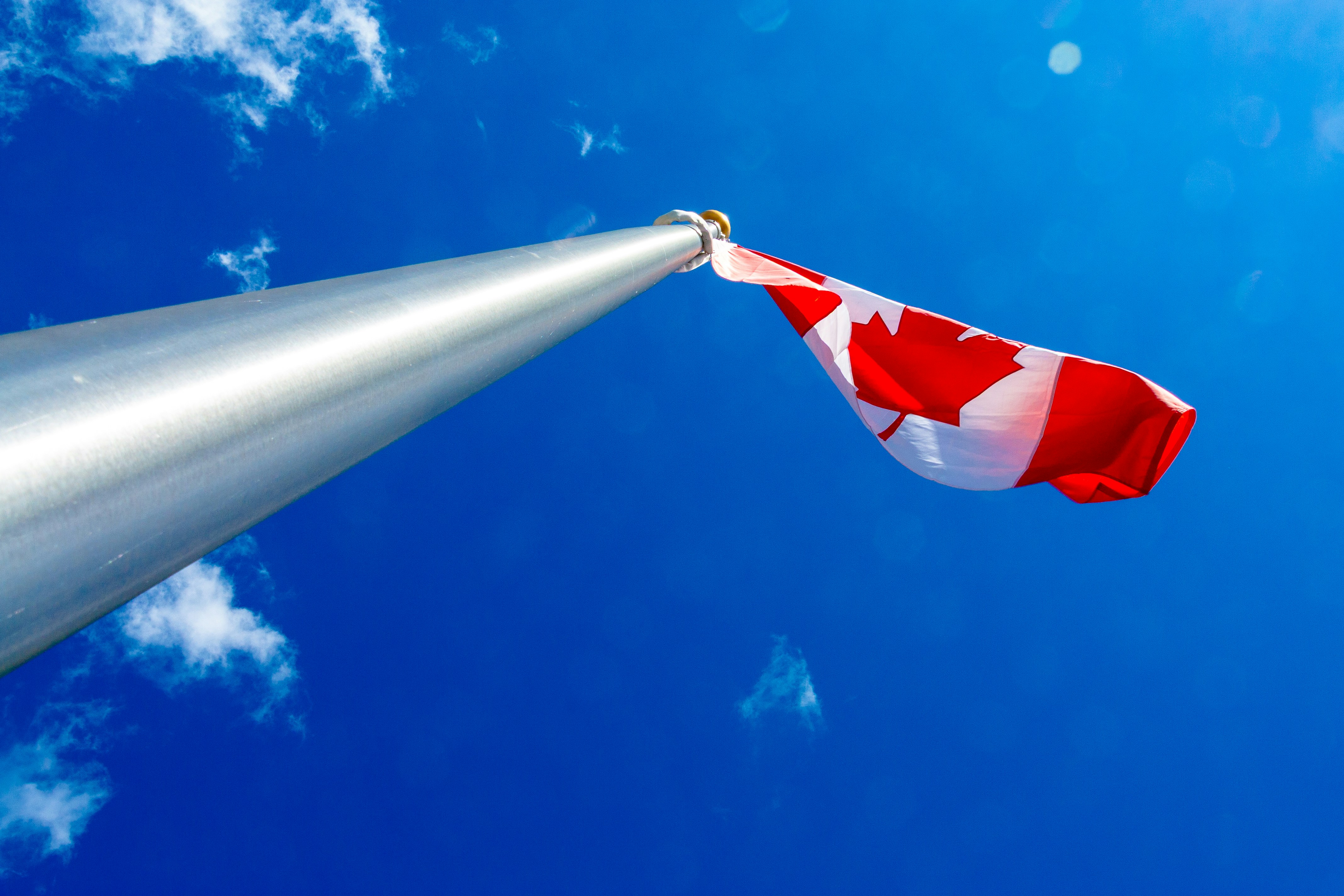 Flag at the Peak: A Canadian Emblem Against a Cerulean Sky