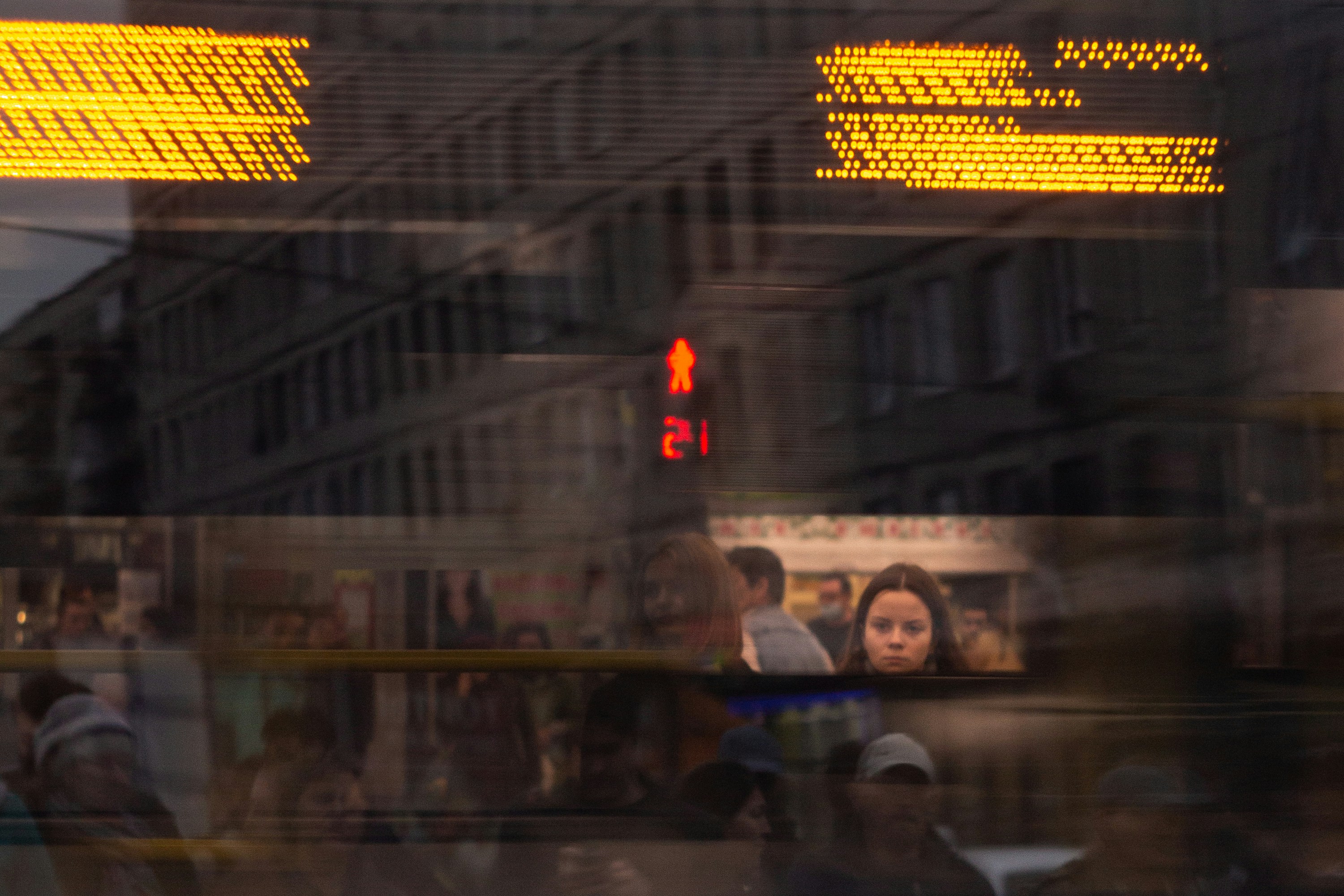 Urban Reflections: Faces in a Blurred Subway Moment