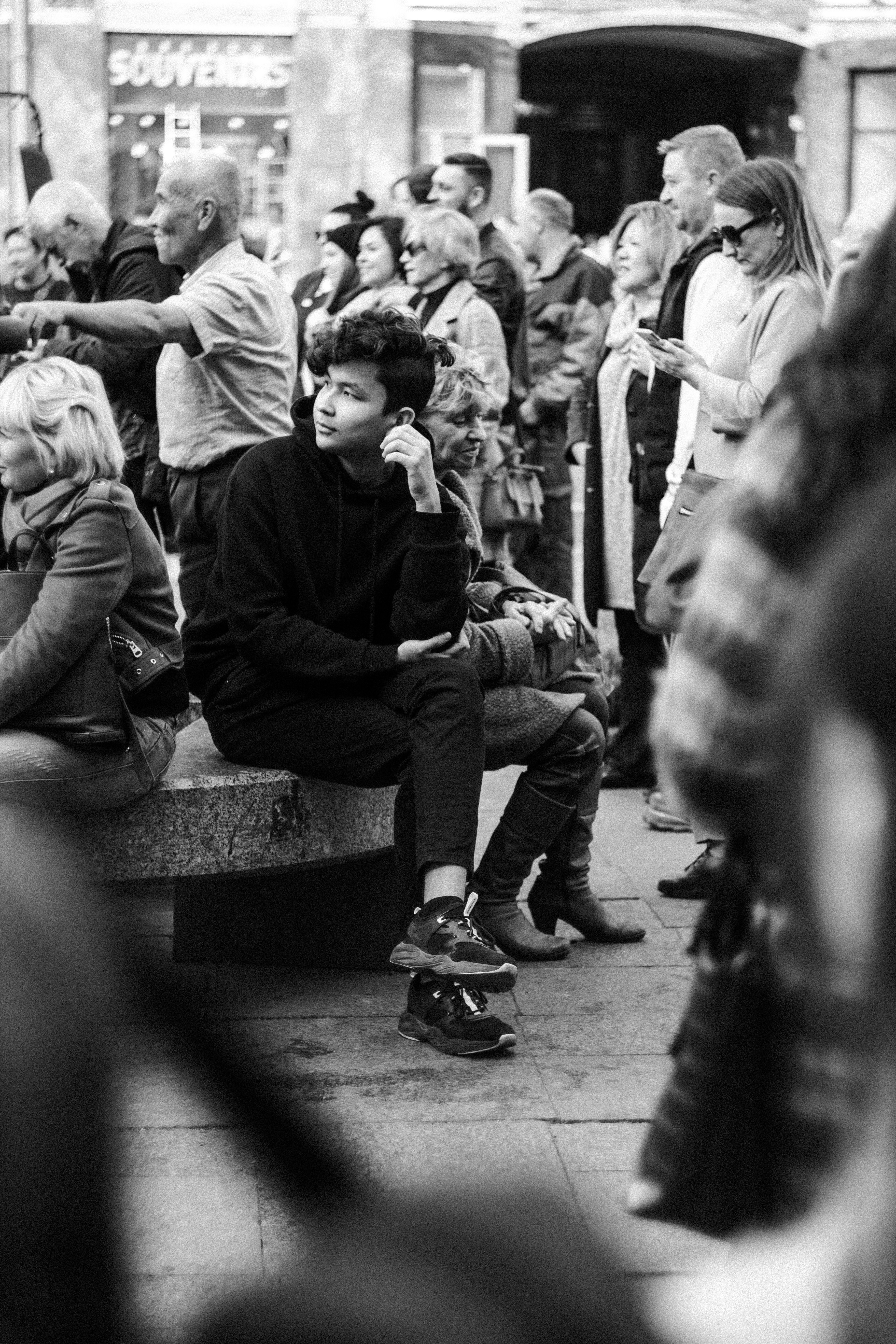 Midday stillness: a student in a sea of urban faces