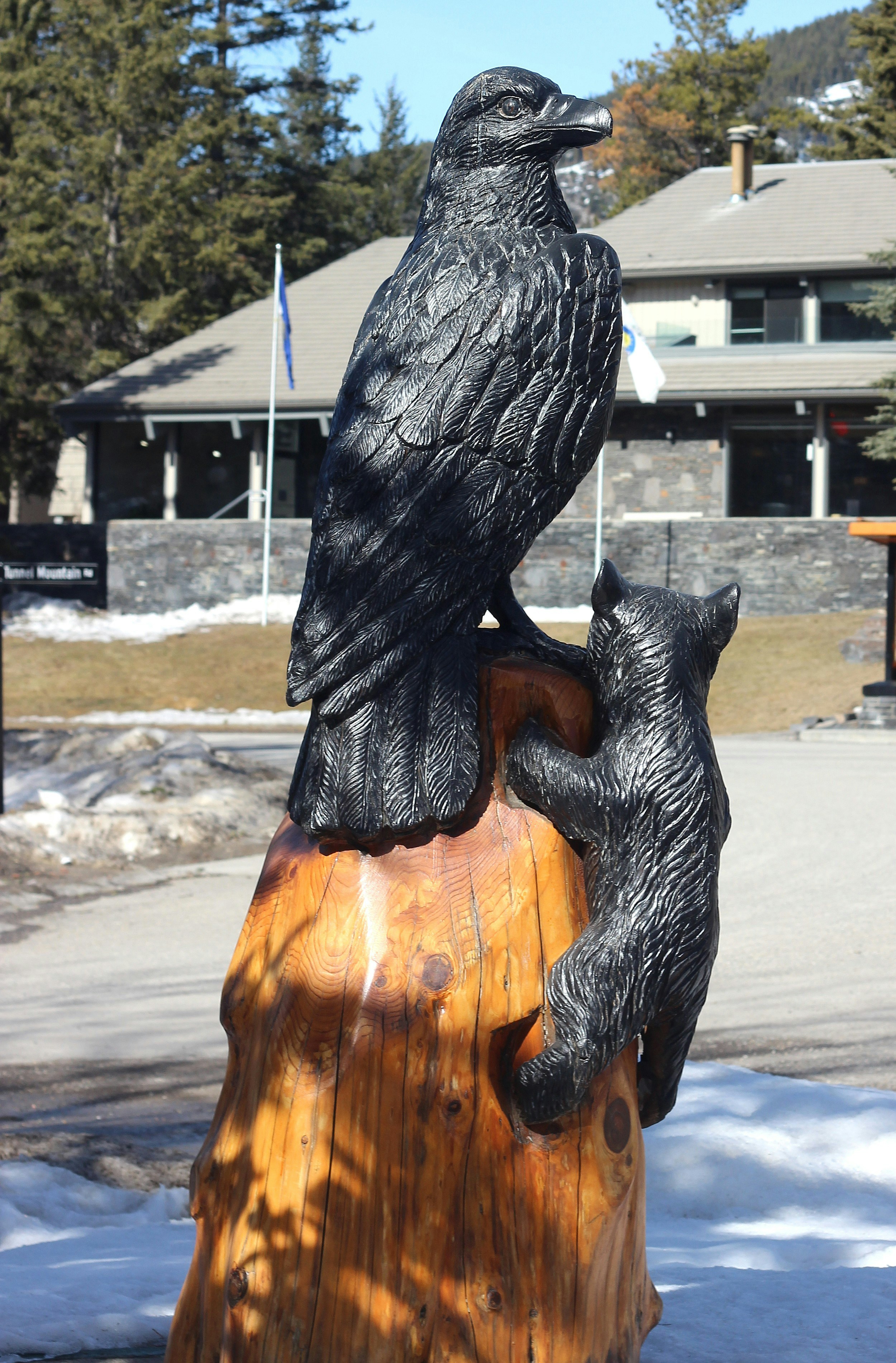 Raven Sentinel: A Carved Duo Standing Guard Over Winter Wood