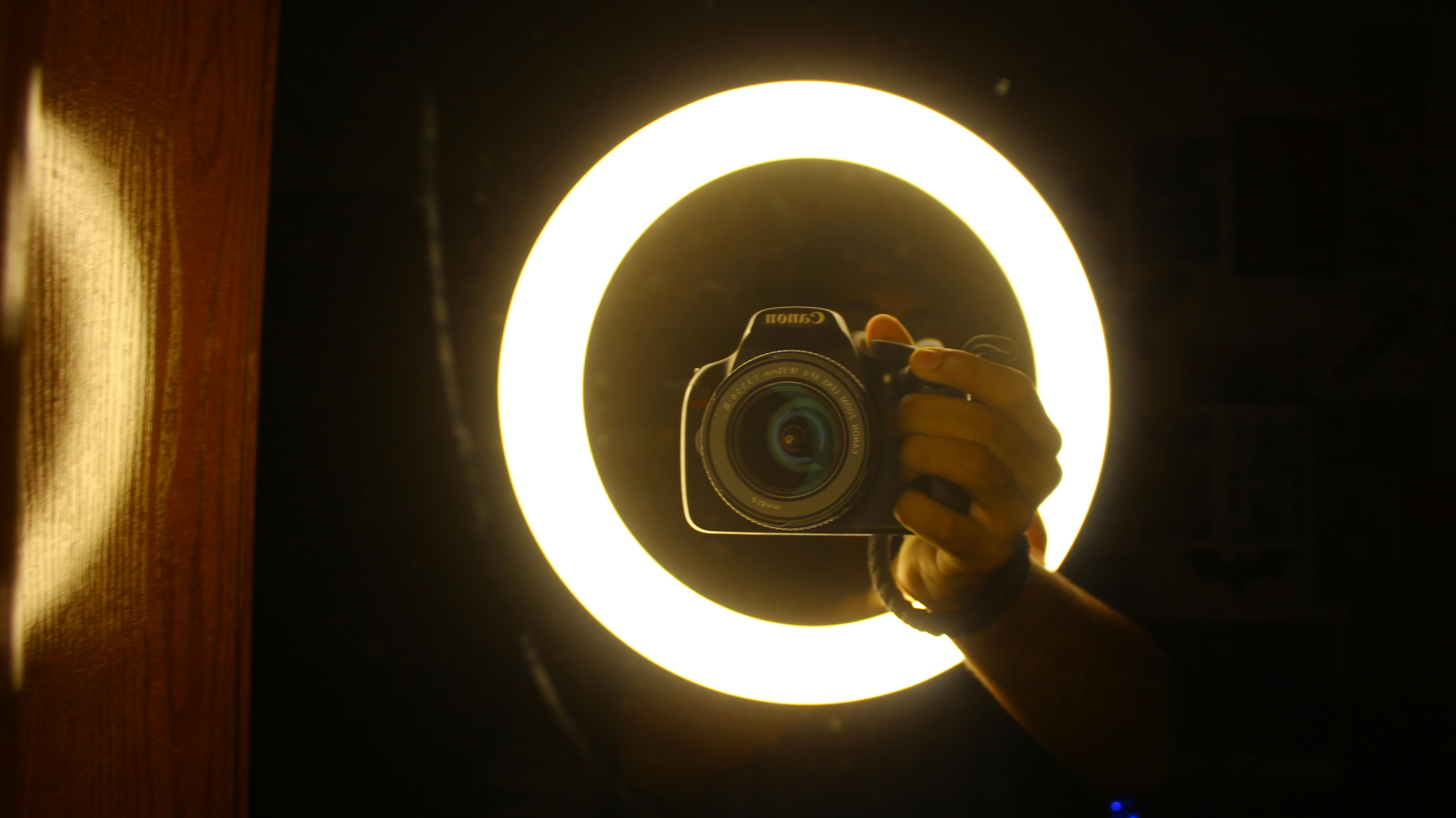 Circular Spotlight: A Photographer Framed by Light