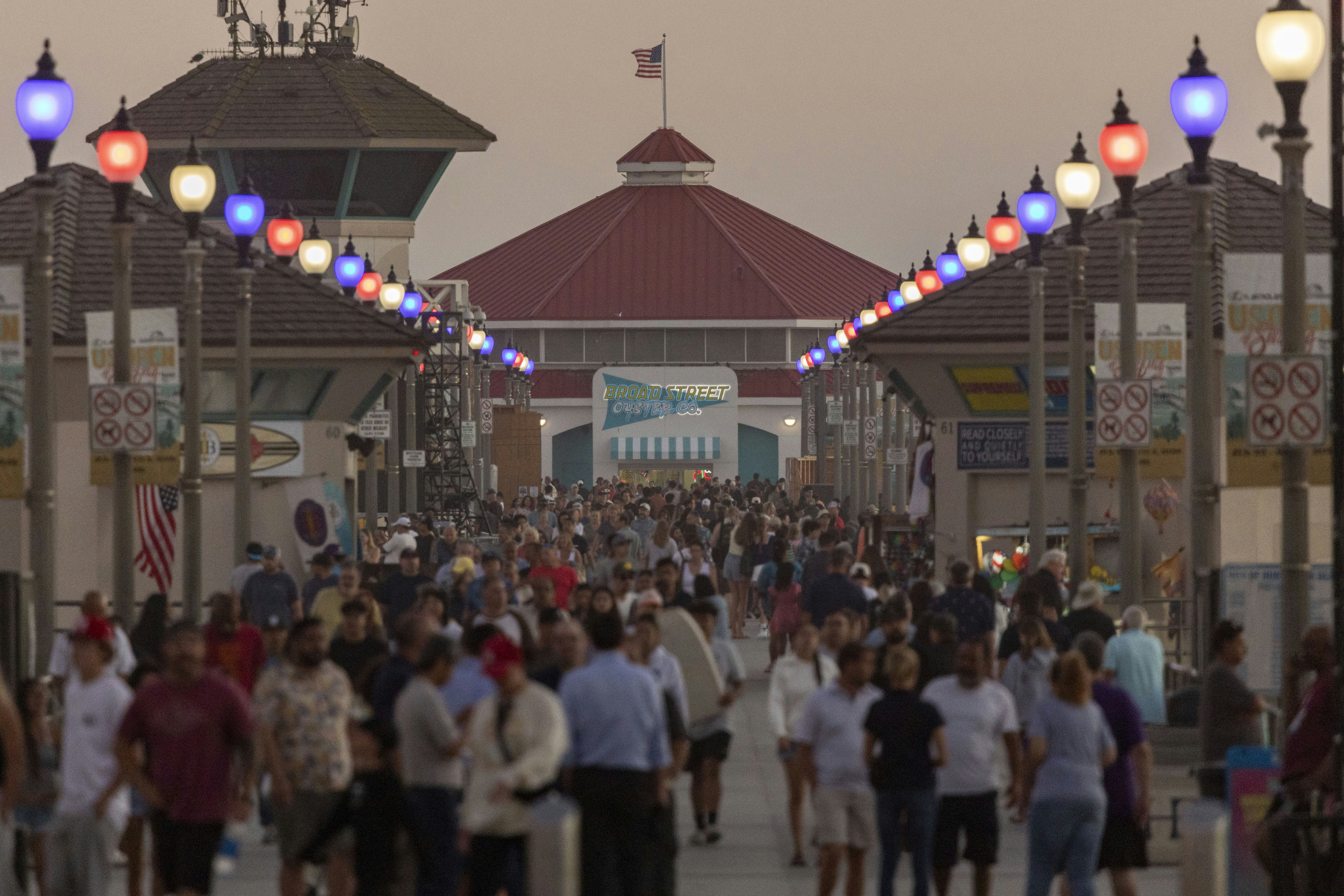 Midday Parade: A Crowd Gathers Under Lanterns to Reach the Pier Gate