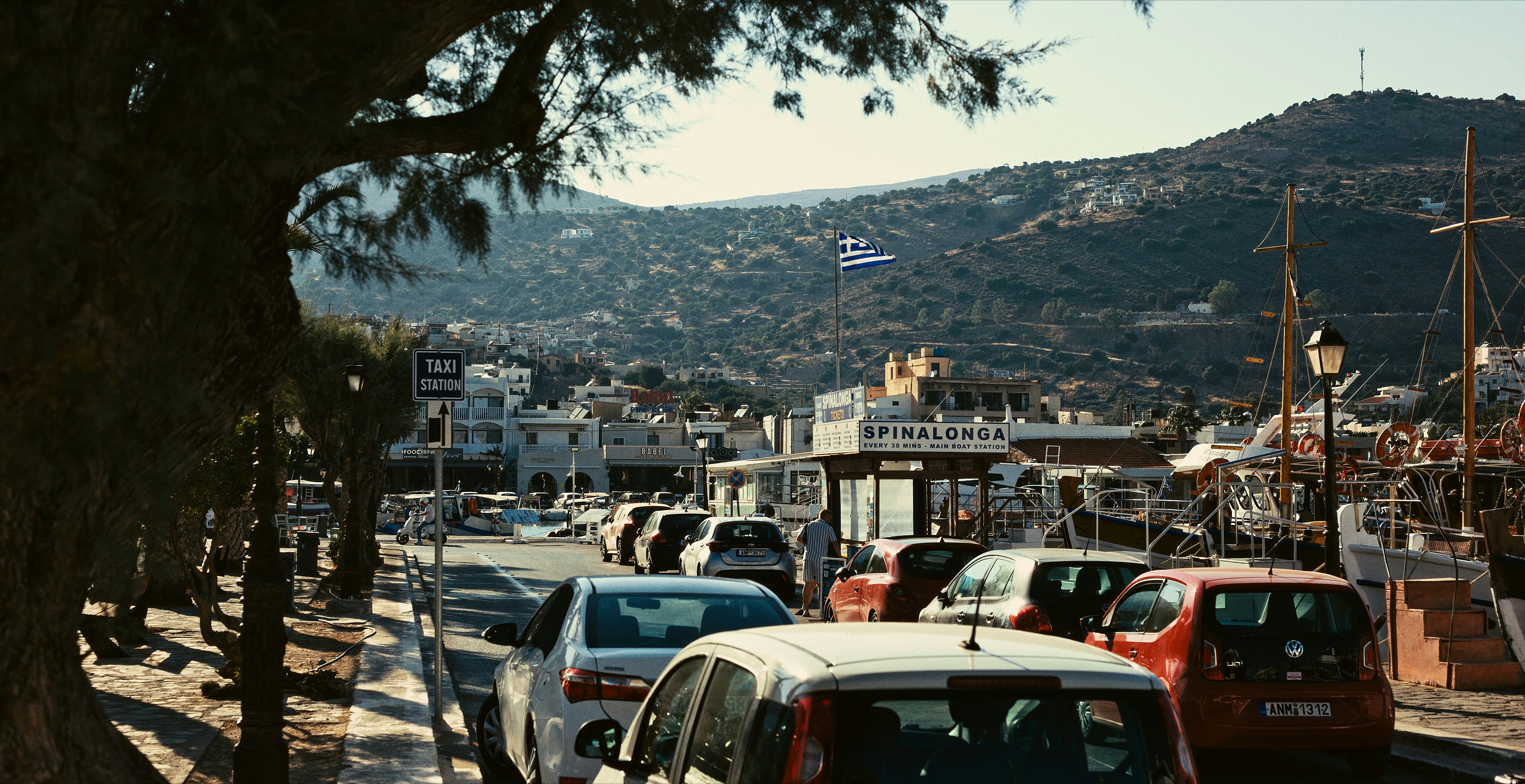 Harbor Street in Spinalonga: A Sunlit Dawn of Stop-and-Go