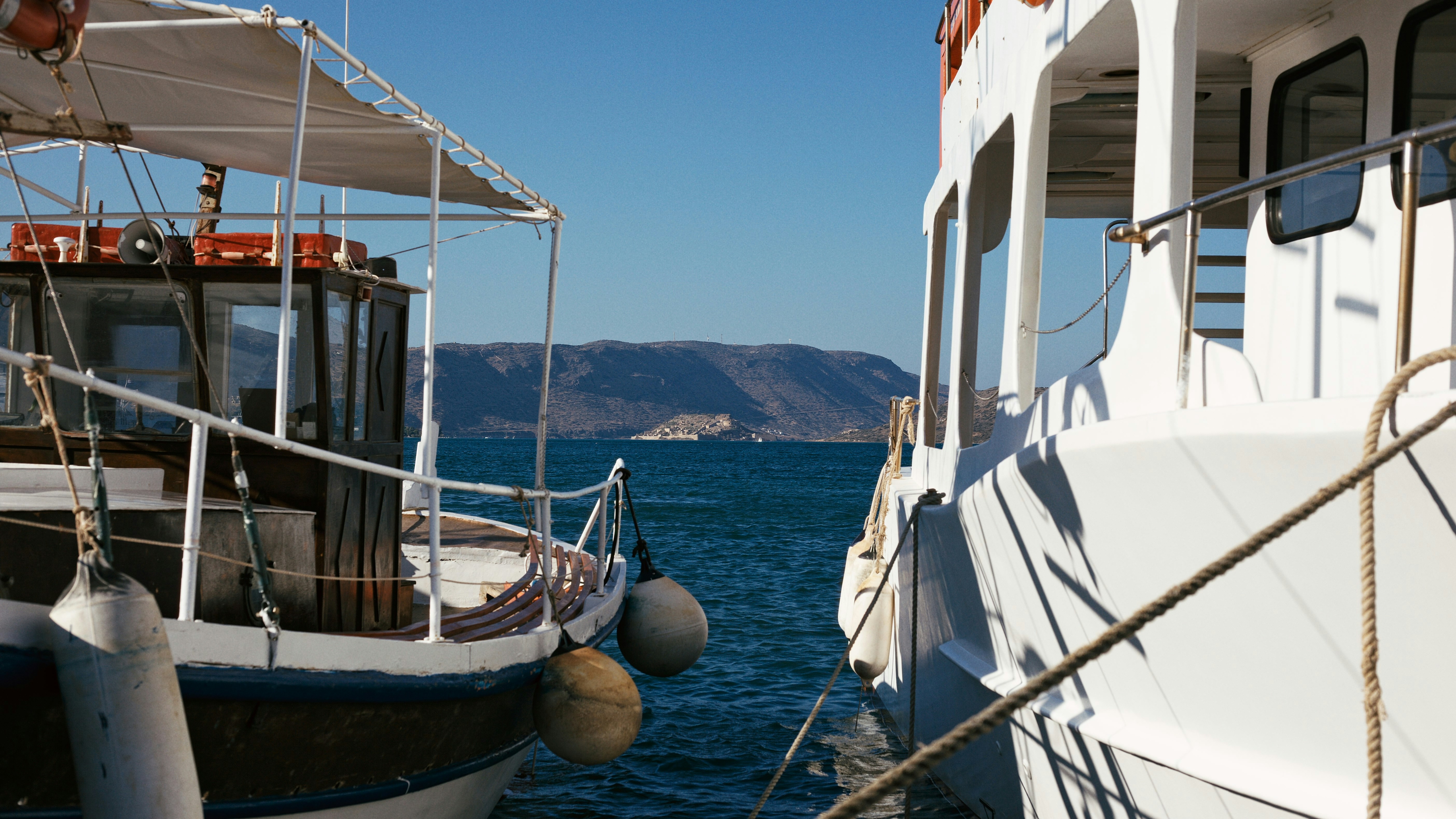 Harbor Between Vessels: A Quiet Moment Amid White Hulls