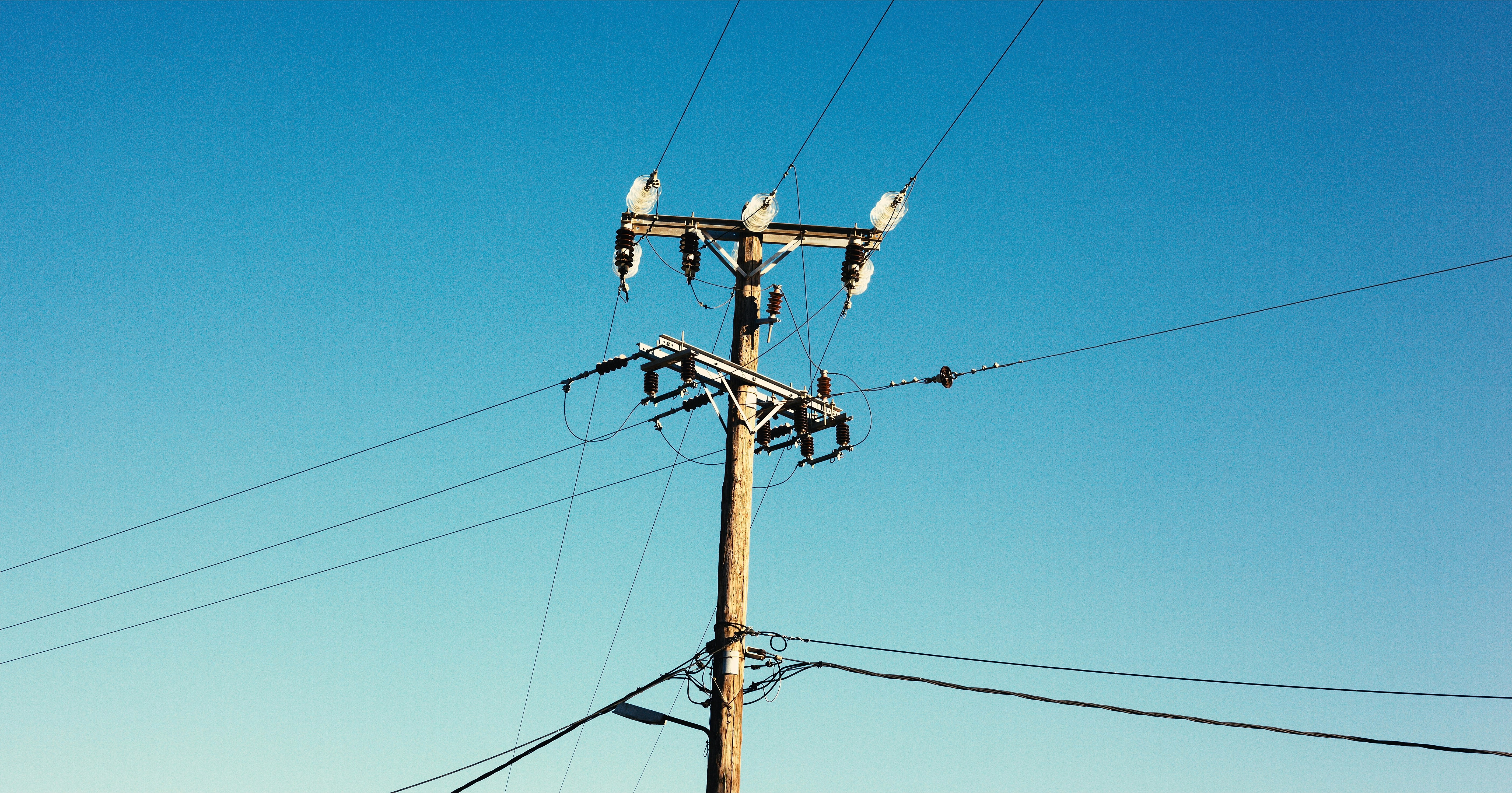 Pole of Silence: A Clear Sky Intersecting Power Lines