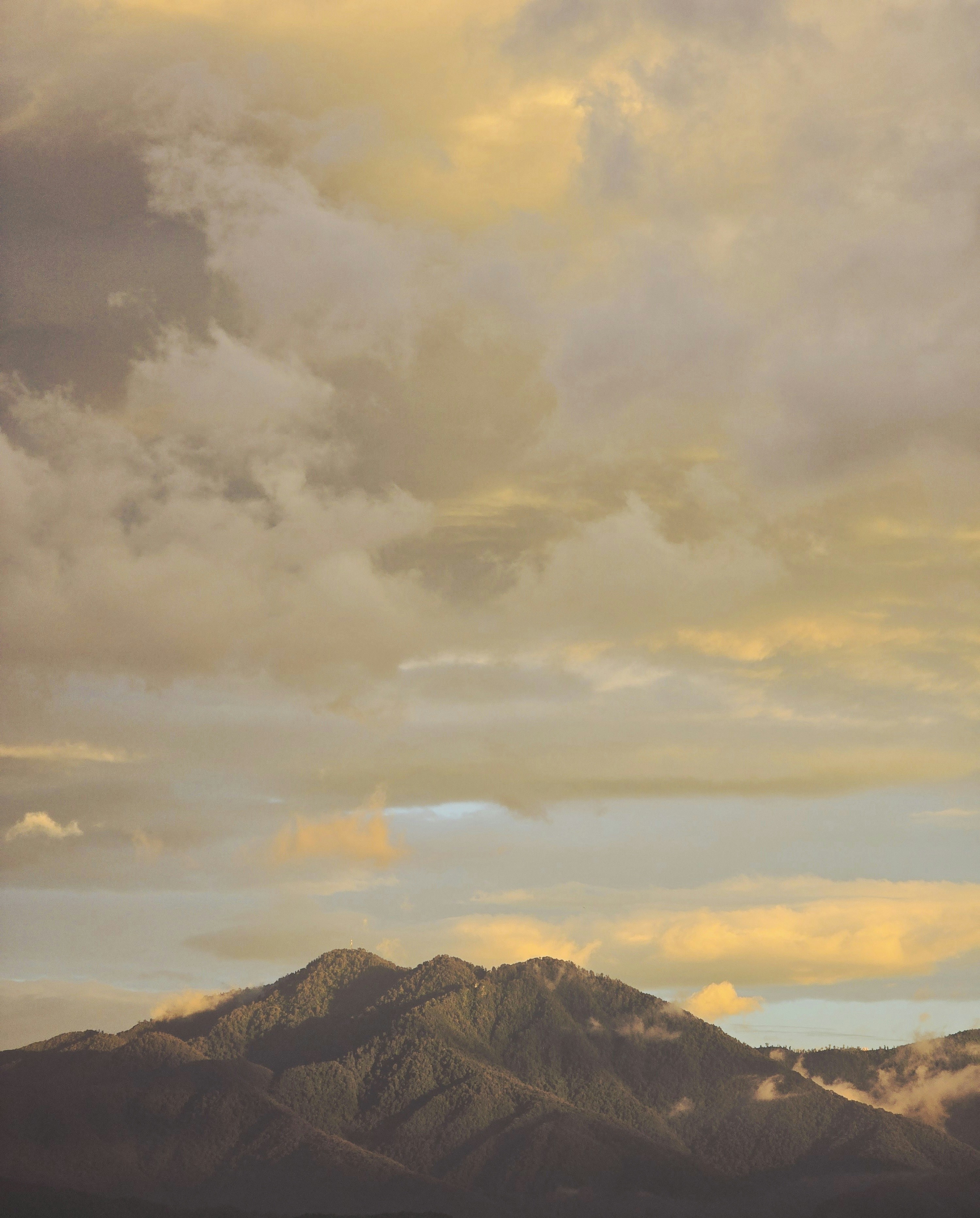 Dawn Over Quiet Peaks: Gentle Clouds Crown a Valley Range