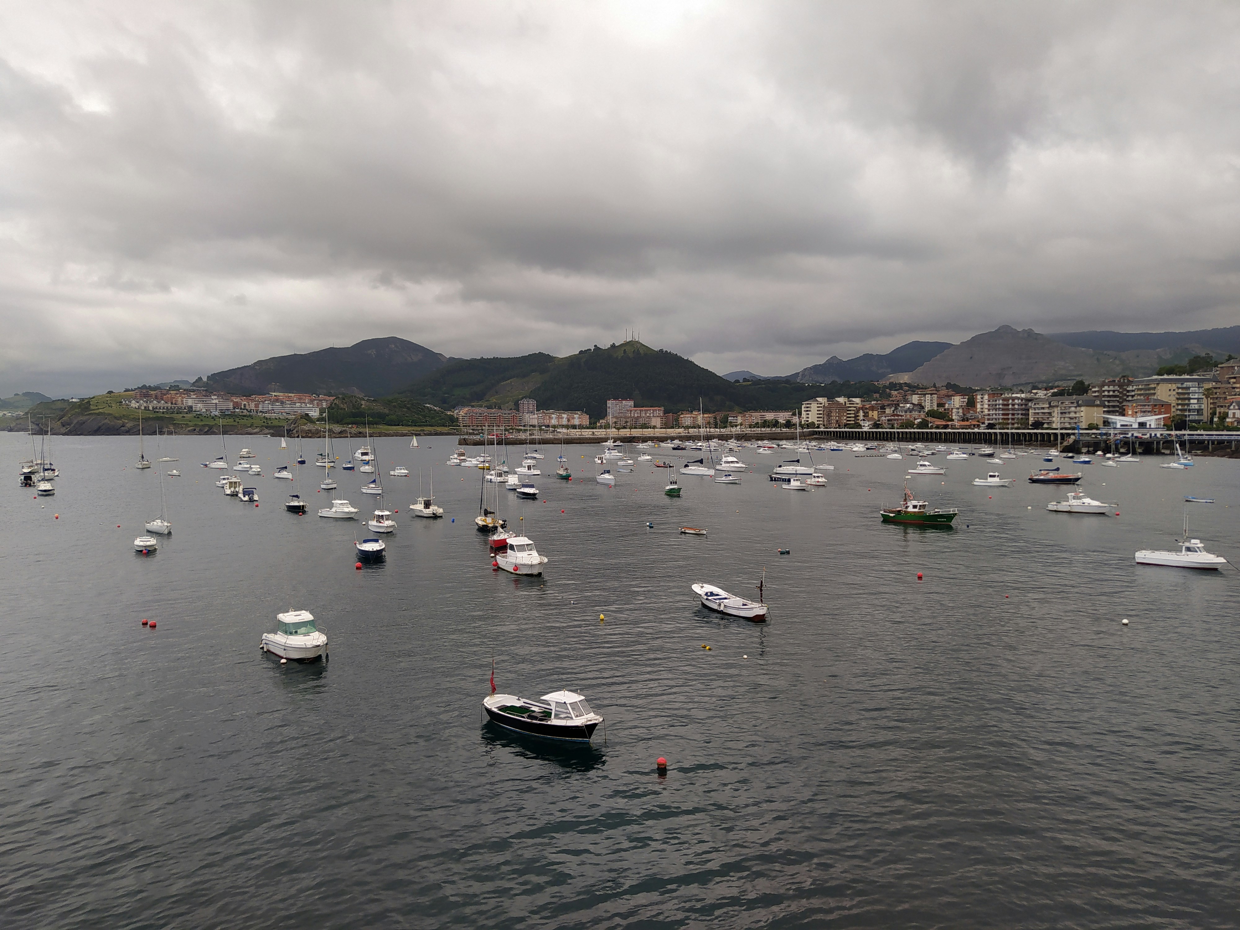 Harbor Mosaic: Boats Quiet Under Clouded Skies