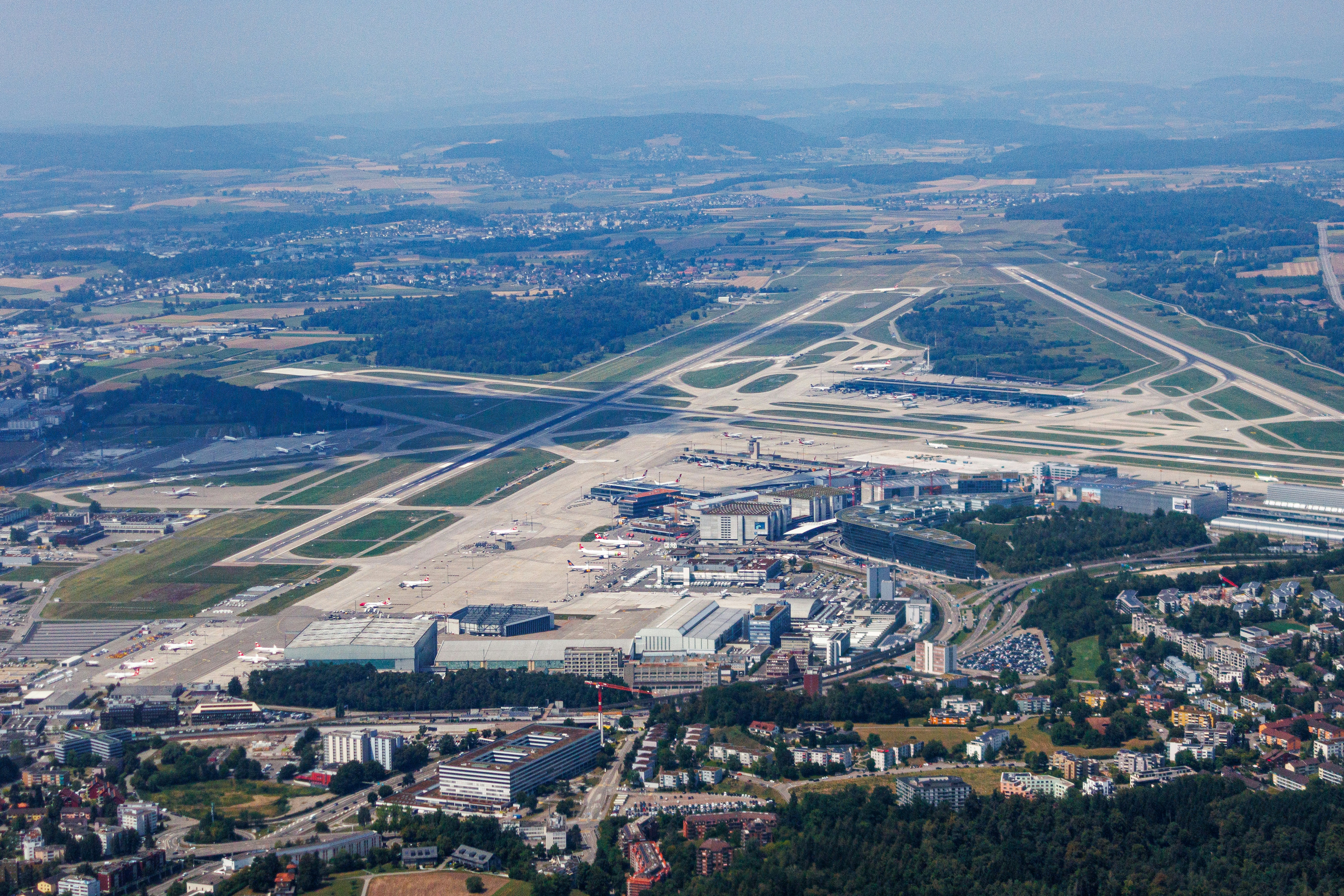 Aerial Tapestry: Runways and City Grid under a Quiet Sky