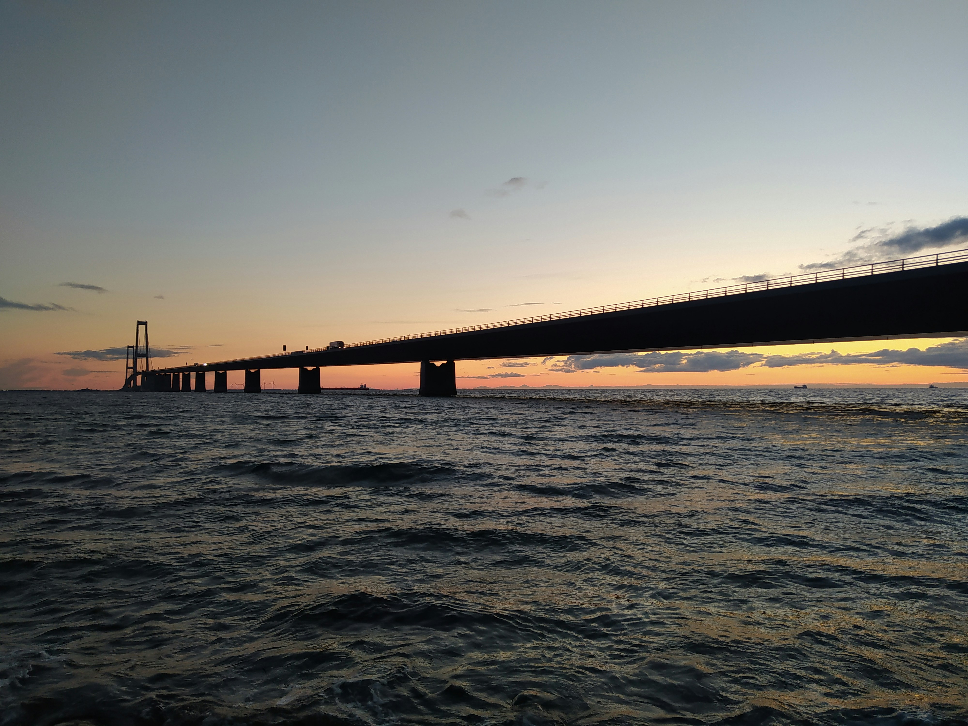 Dusk Bridge: Silhouette Over Quiet Seas