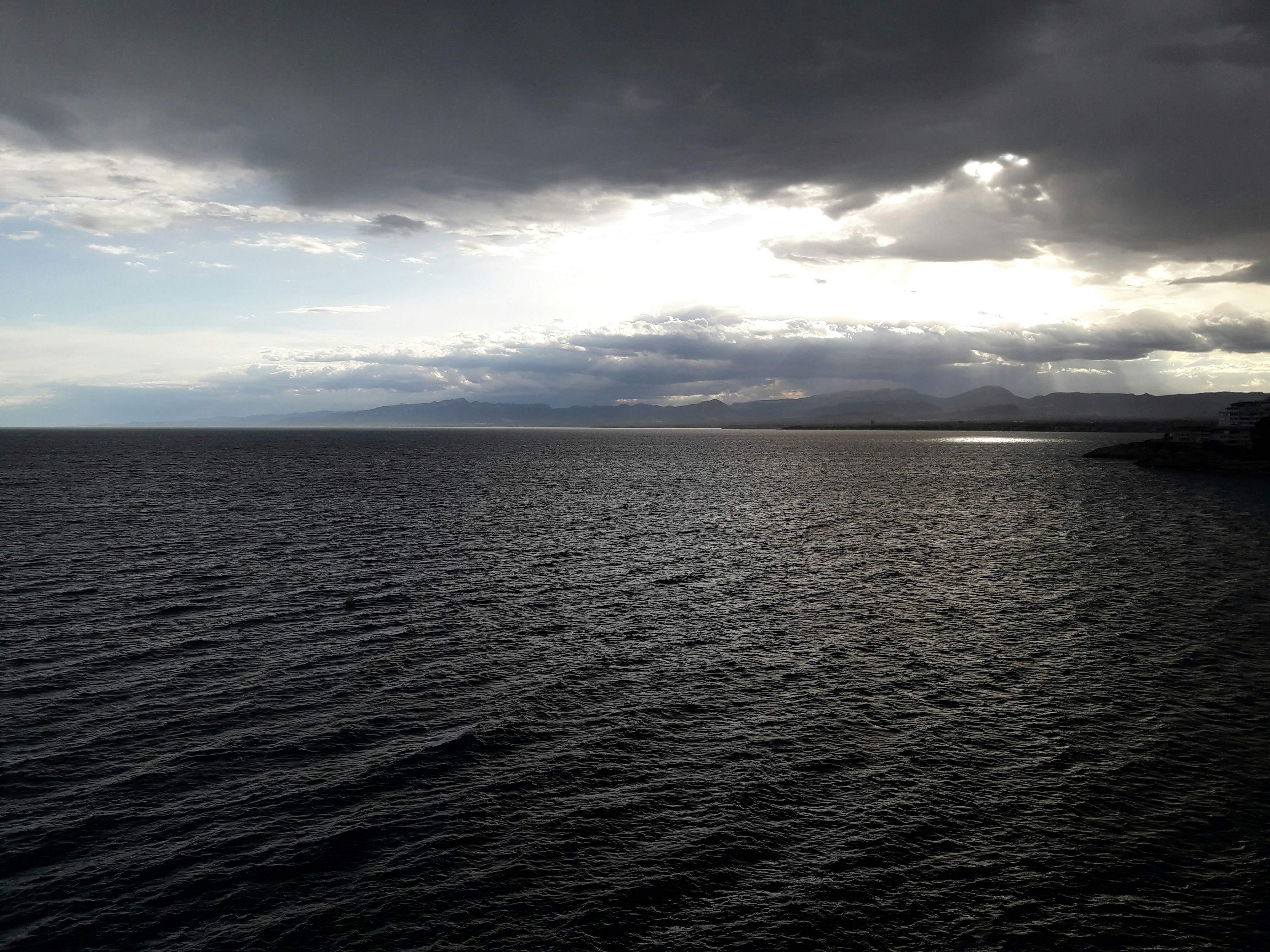 Dramatic Horizon Over Stormy Sea at Distant Crest