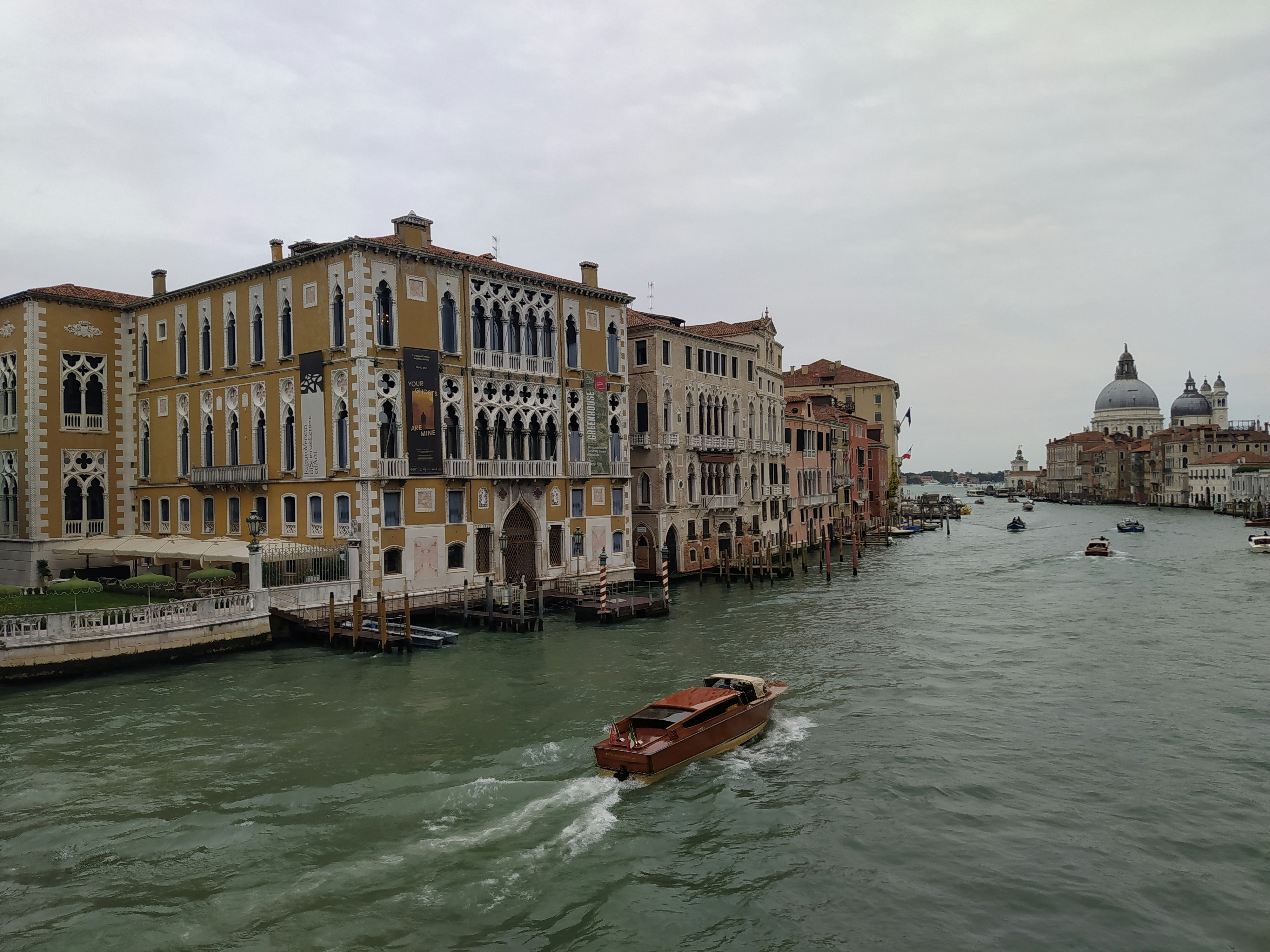 Gondolas Glide Past Venetian Facades Under a Softly Overcast Sky
