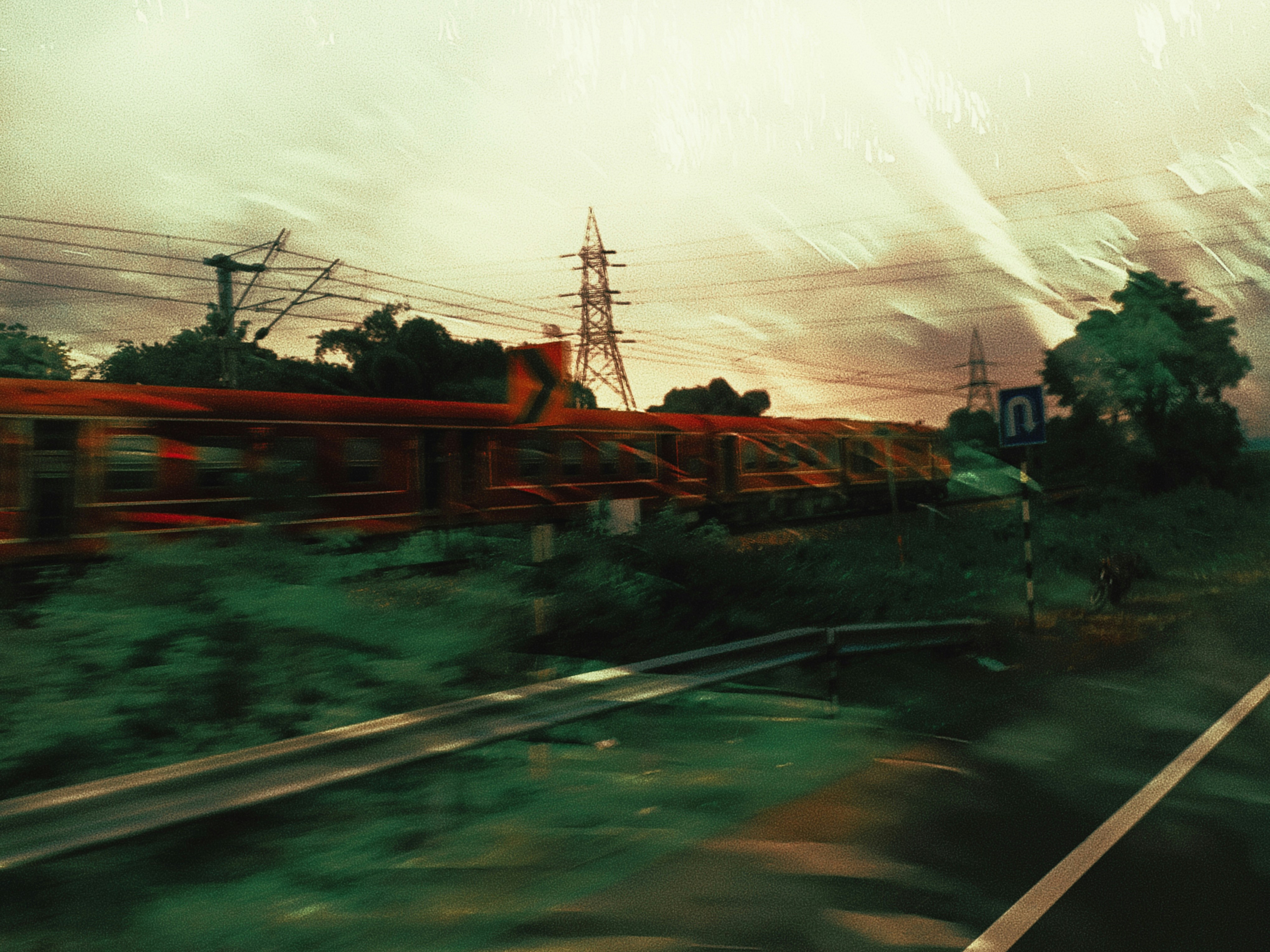 Railway in Motion: Blurred Sunset Train Across a Green Corridor