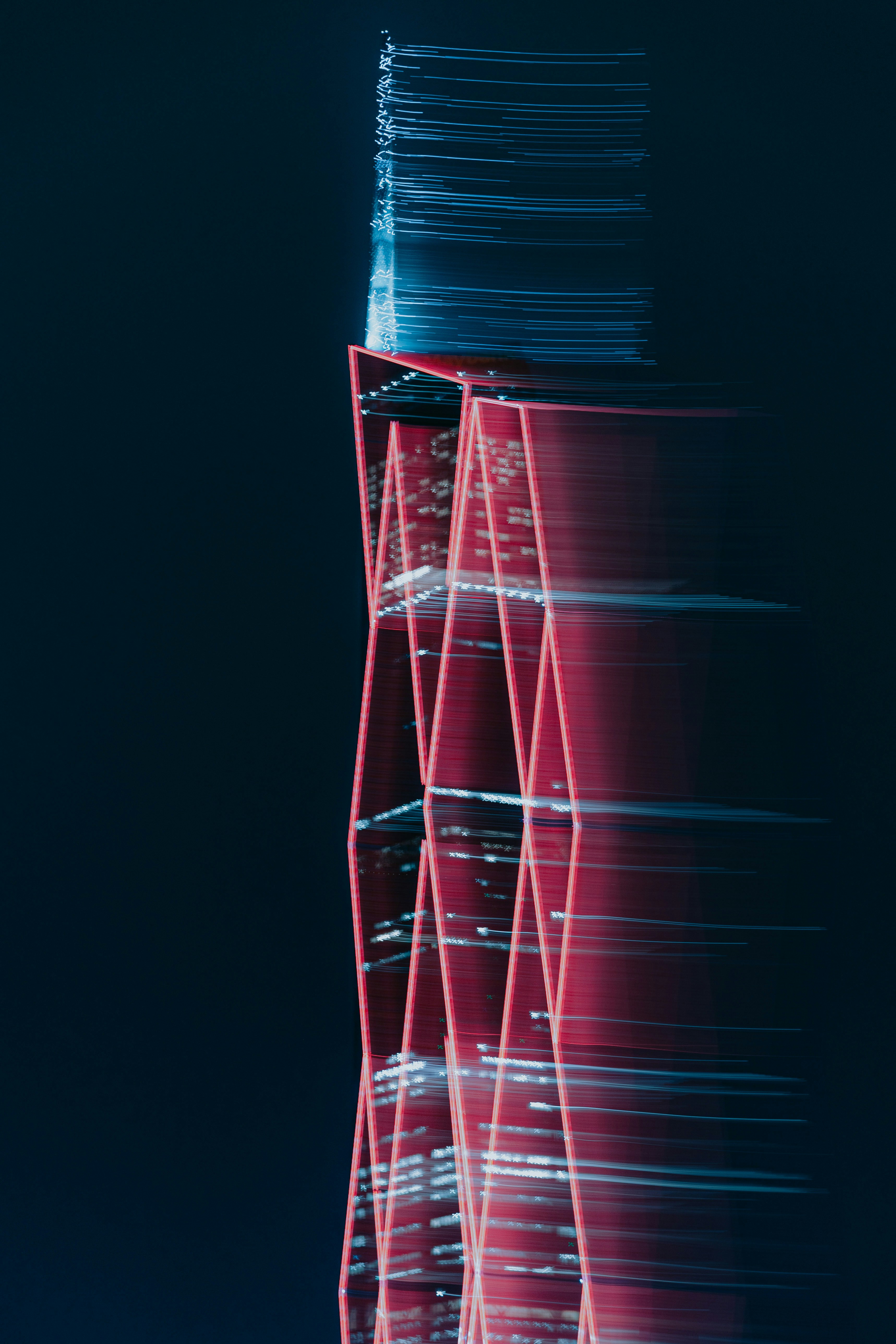 Neon Facets: A Tilted Tower of Red Diamond