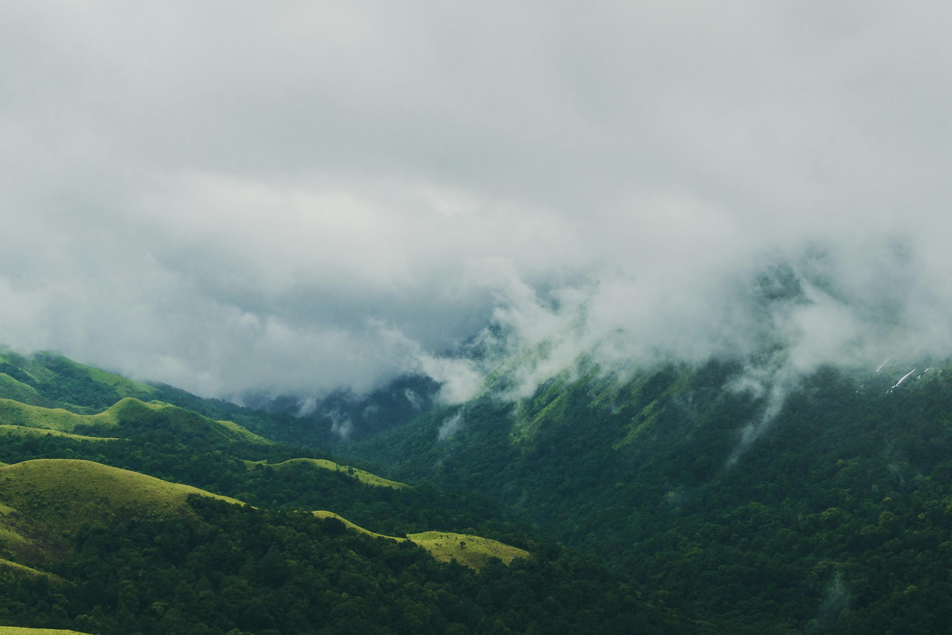 Mist-Lifted Ridge: Green Summits Beneath Low Clouds