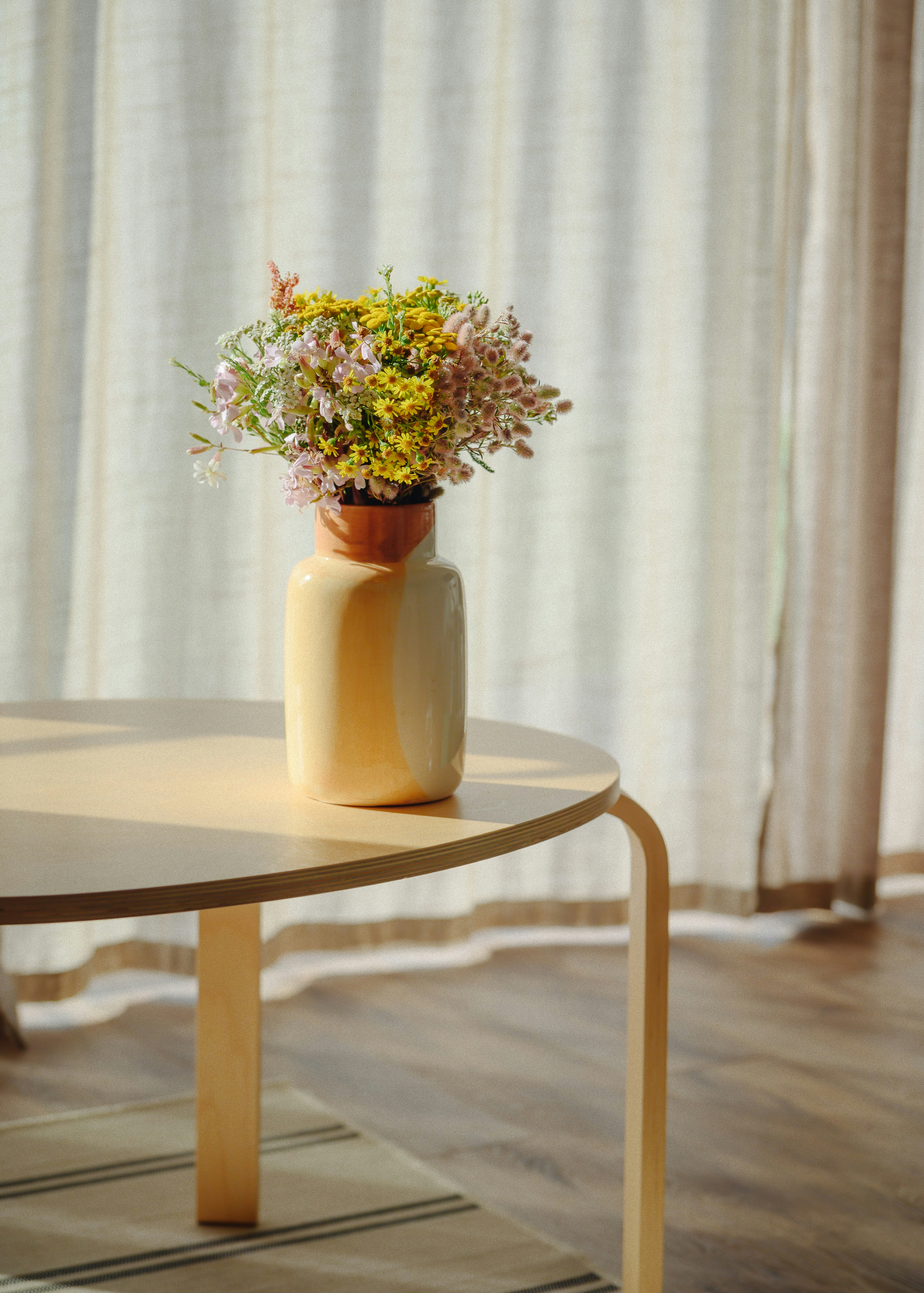 Sunlit Bouquet in a Warm Ceramic Vase on a Minimal Table