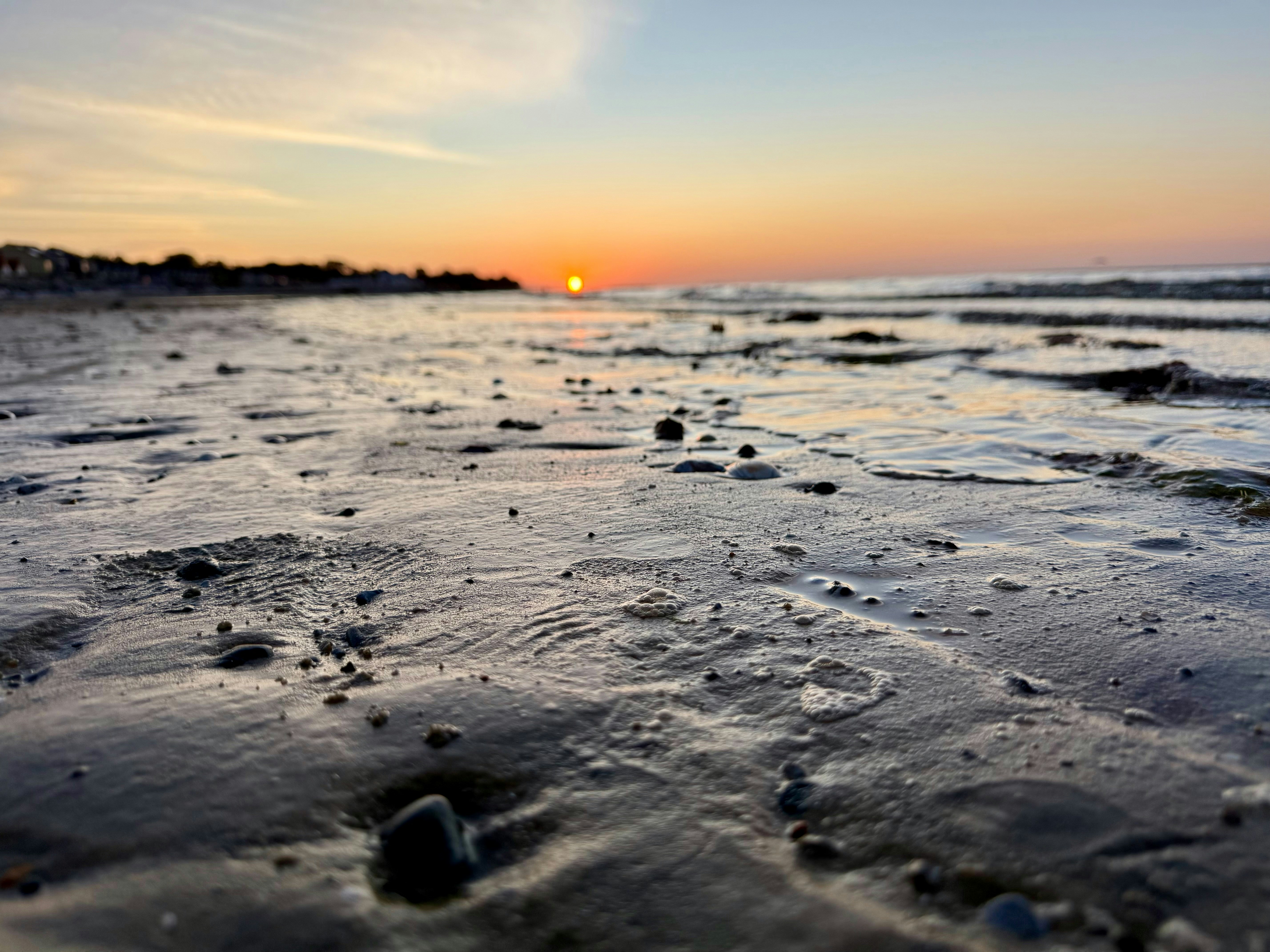 Sunlit Shore: Low Tide Echoes at Dusk