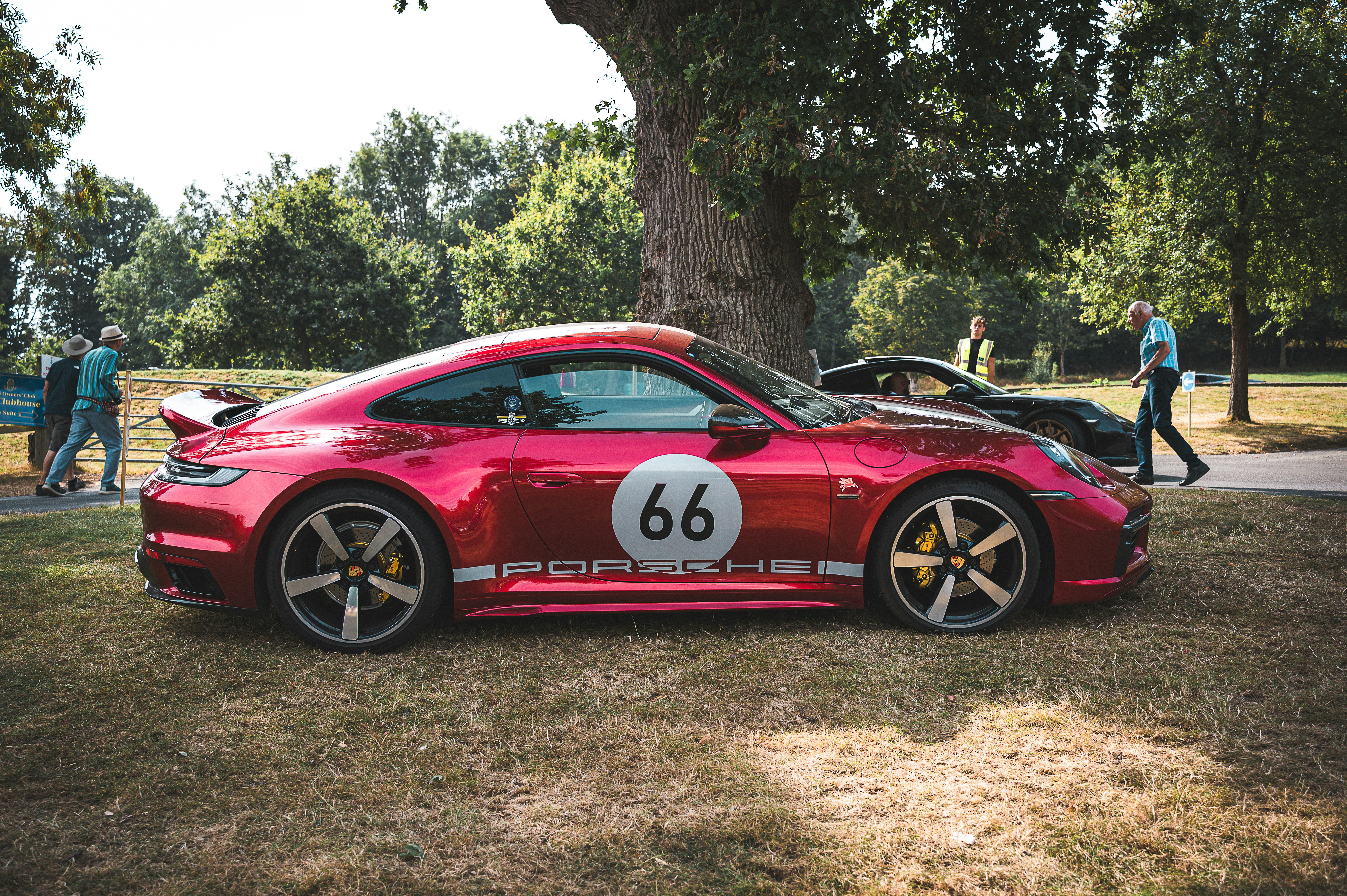 Red Porsche Heirloom: A polished track silhouette in a sunlit park