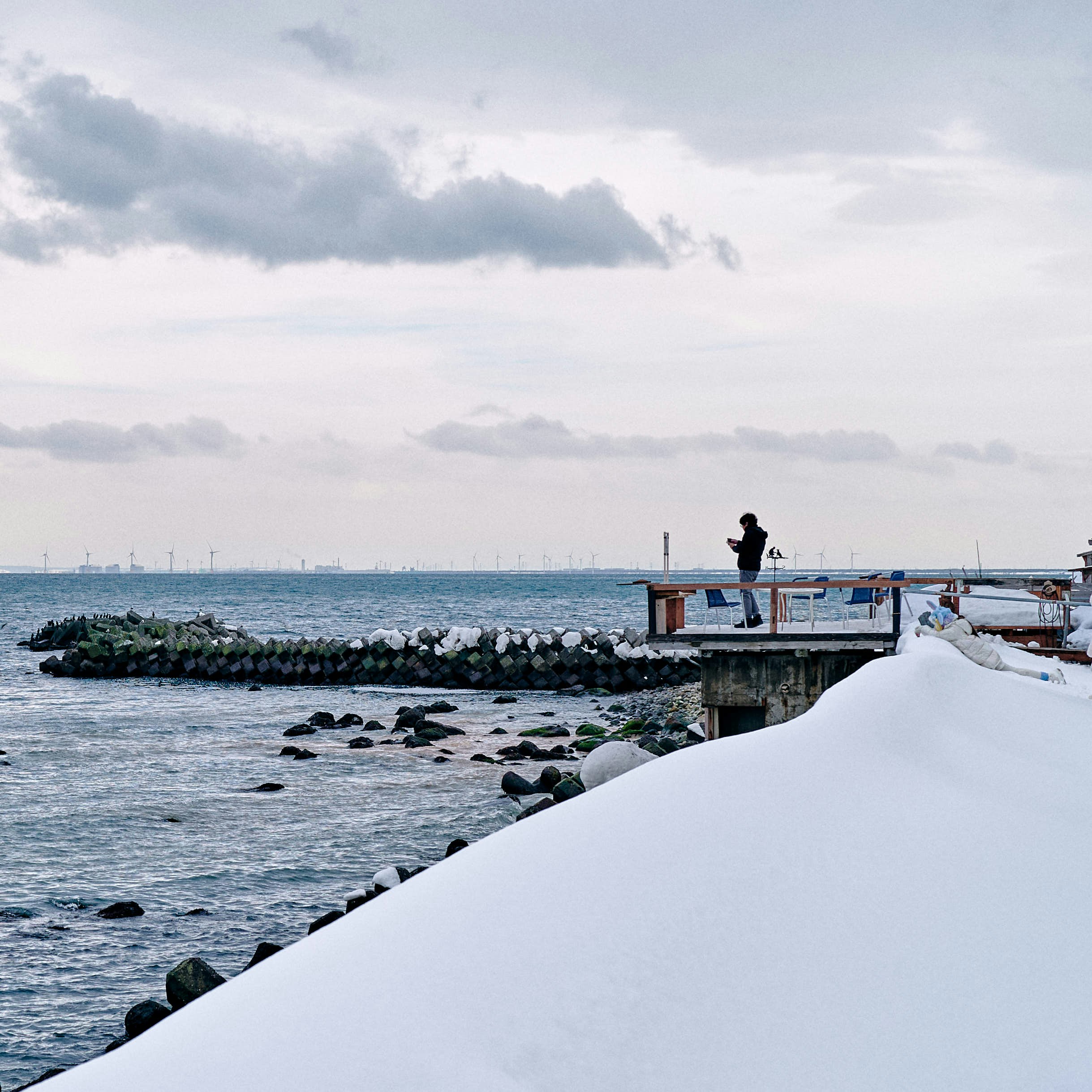 Snowy Pier at Distant Horizon