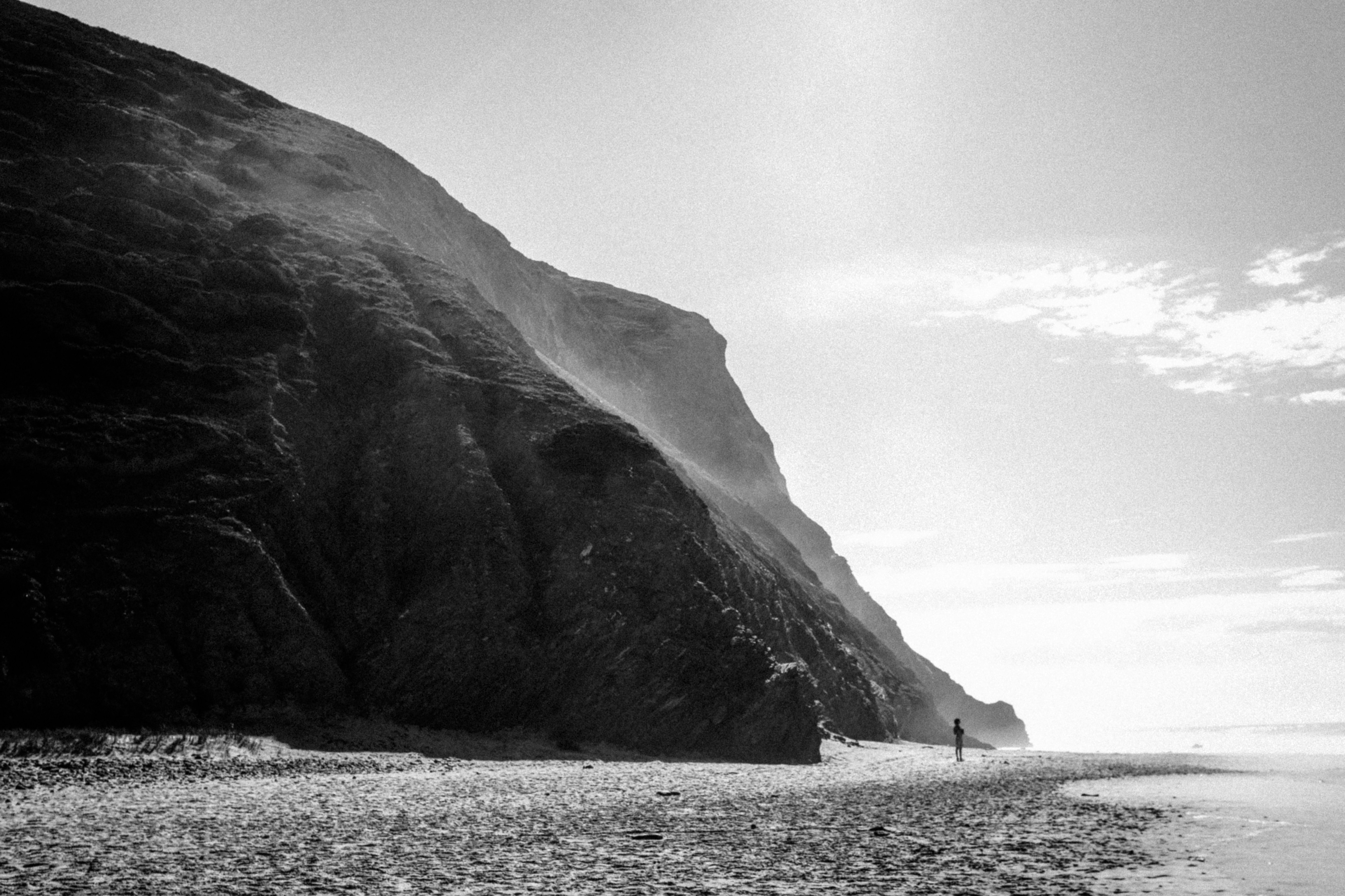 Monolithic Cliff Meets Quiet Shore
