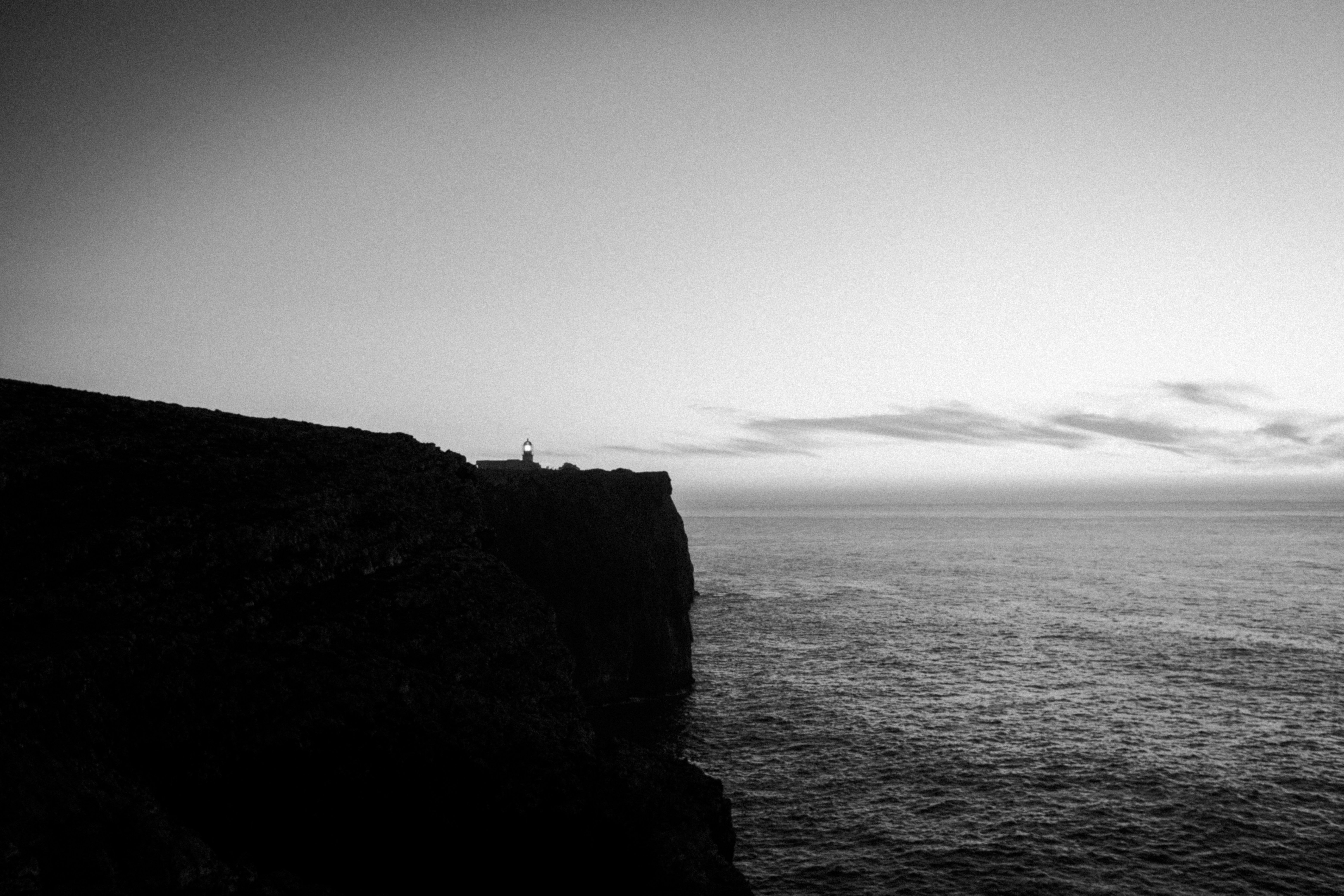 Cliff Edge Sentinel: A Lone Lighthouse at Dusk