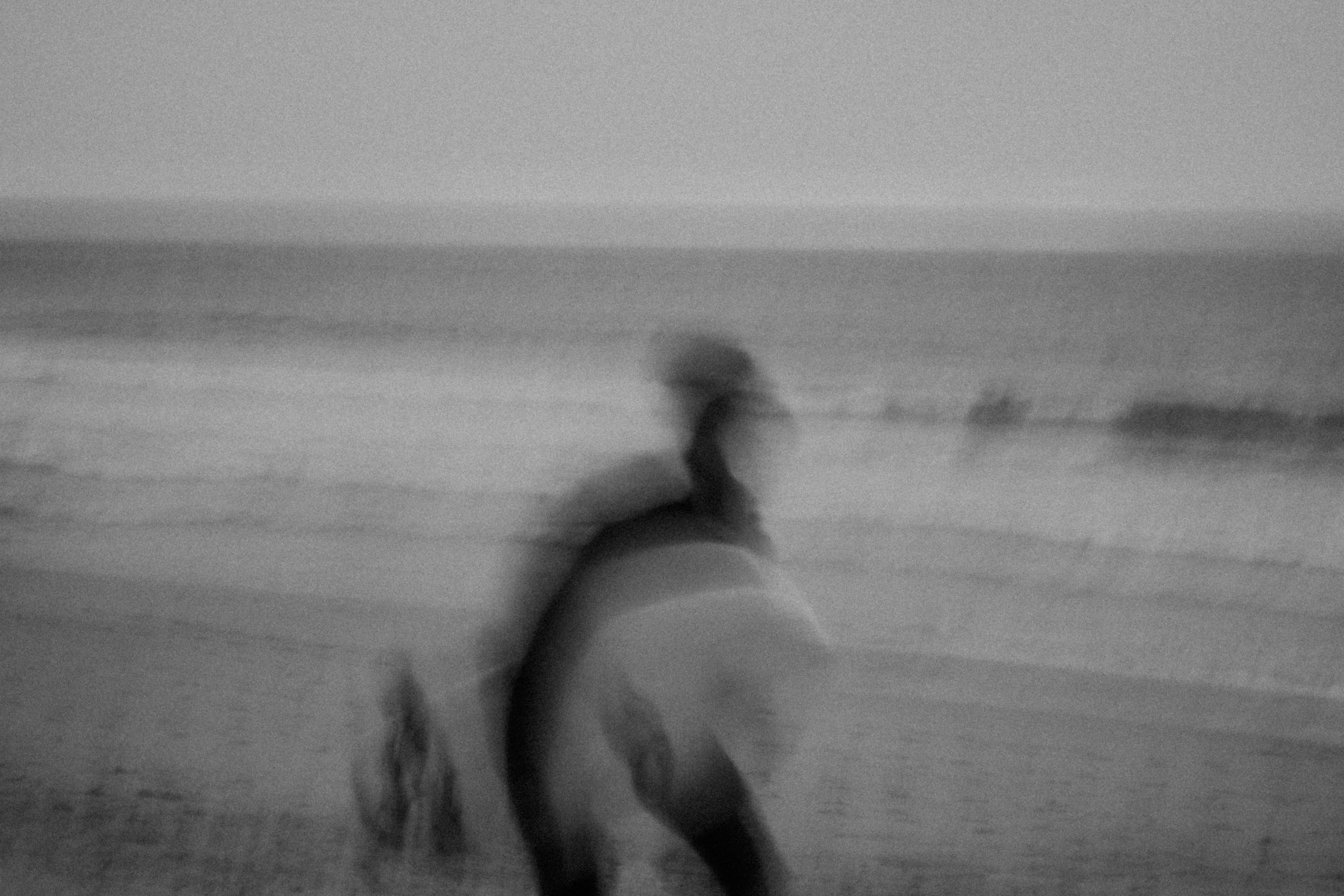 Ghost on the Shore: A Blurred Moment by the Sea