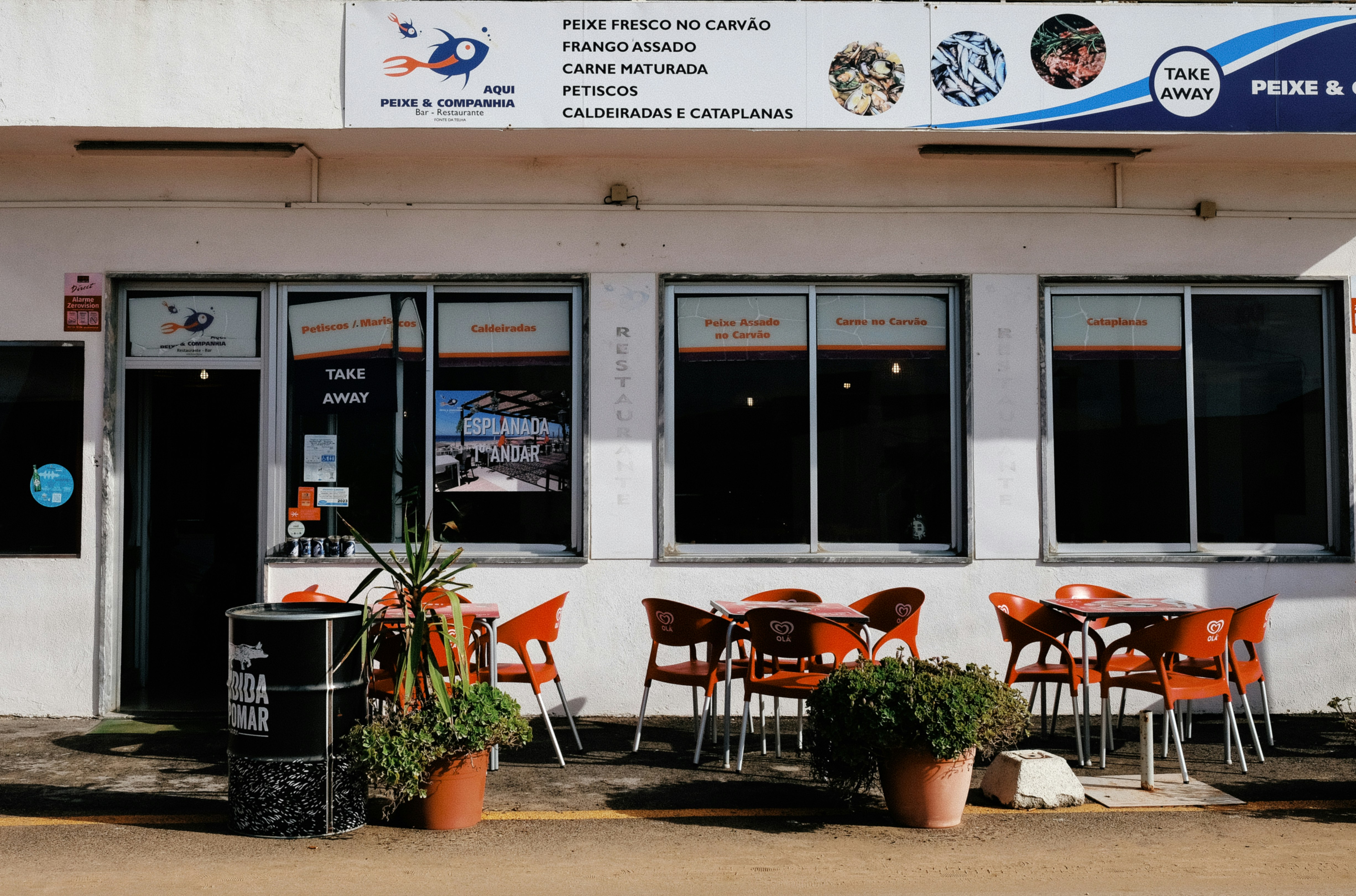 Sunlit Café Terrace with Orange Chairs
