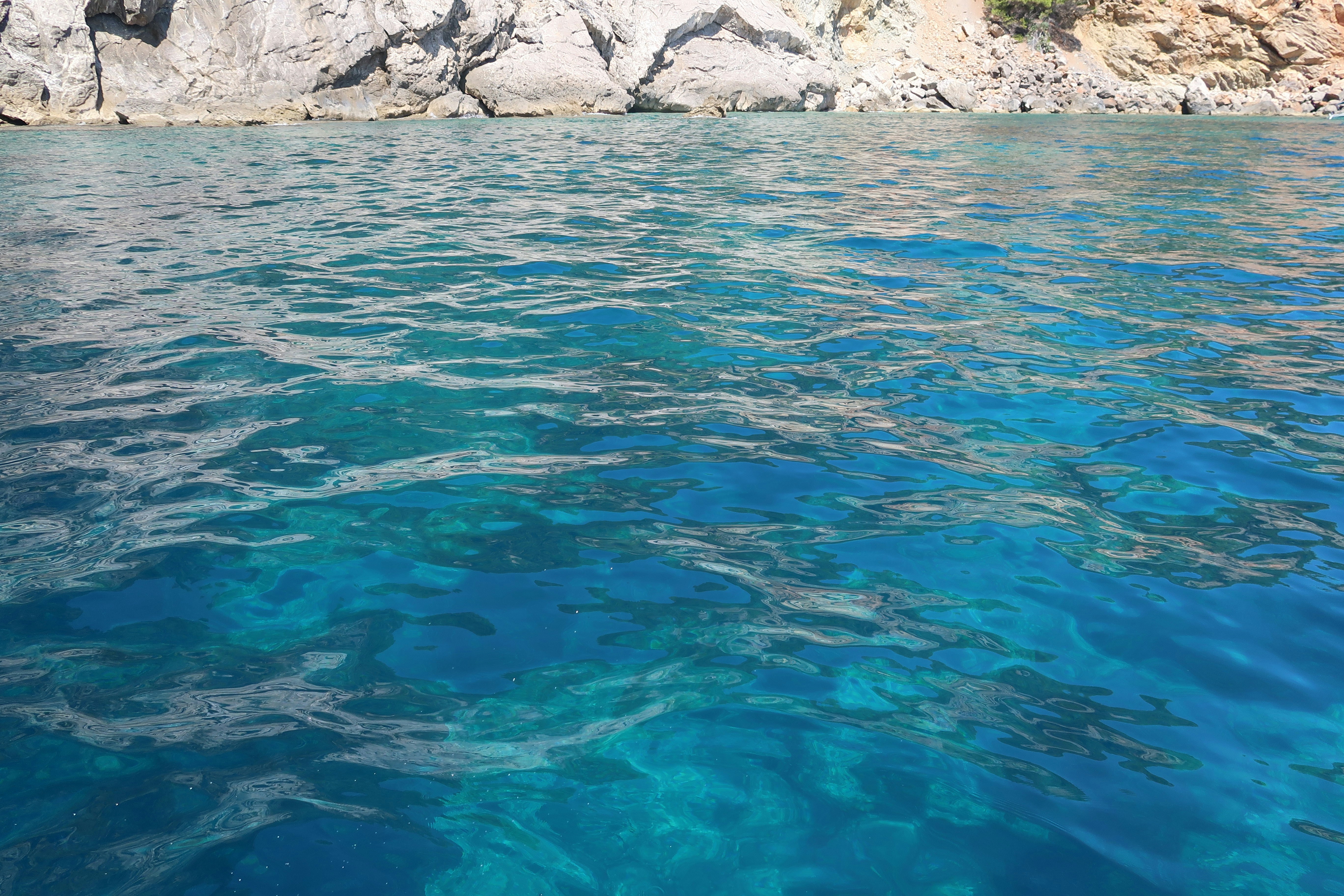Azure Depths: Clear Water Meeting Rugged Coast