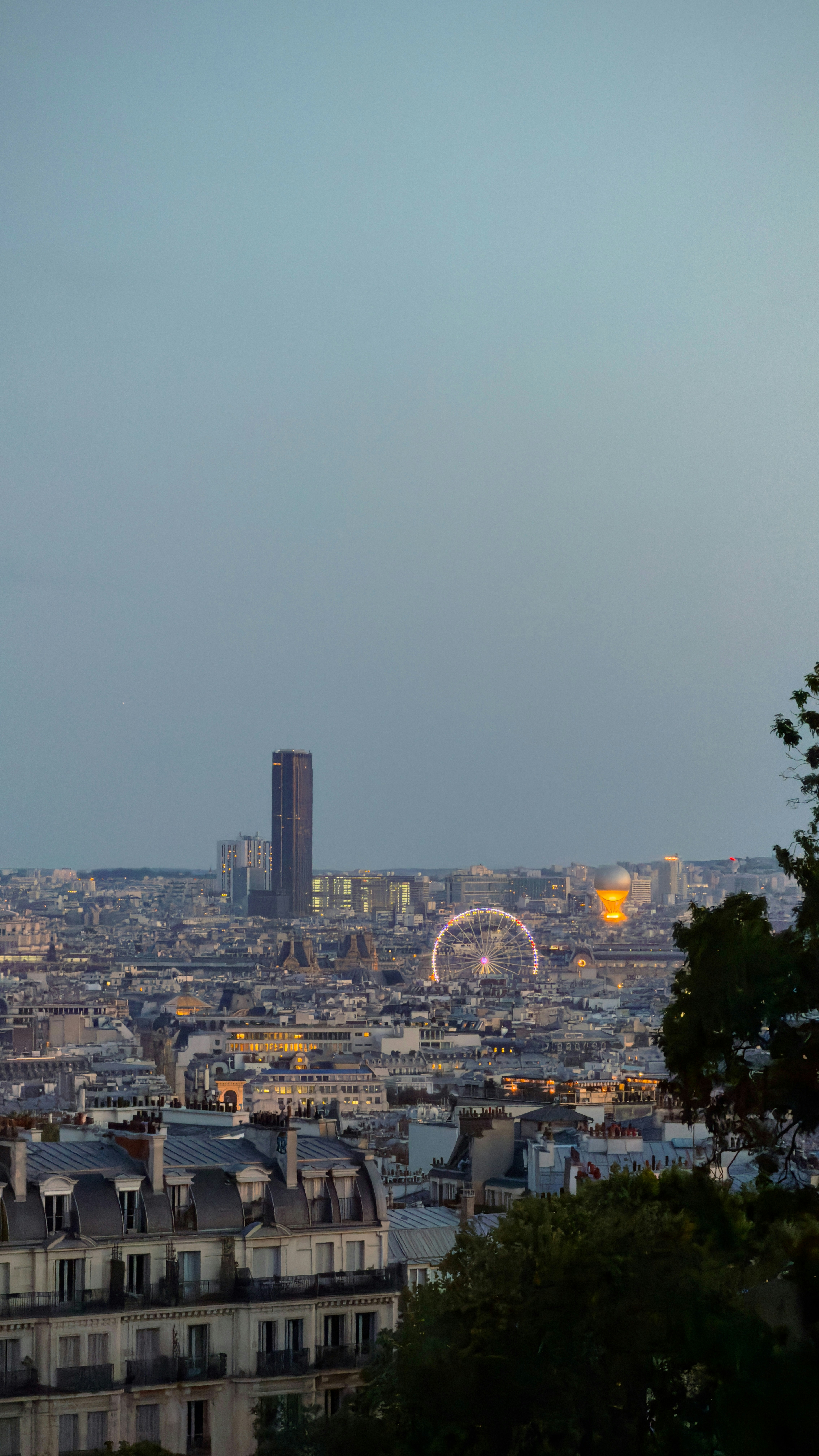 Paris at Dusk: The City’s Wheel and Rooftops