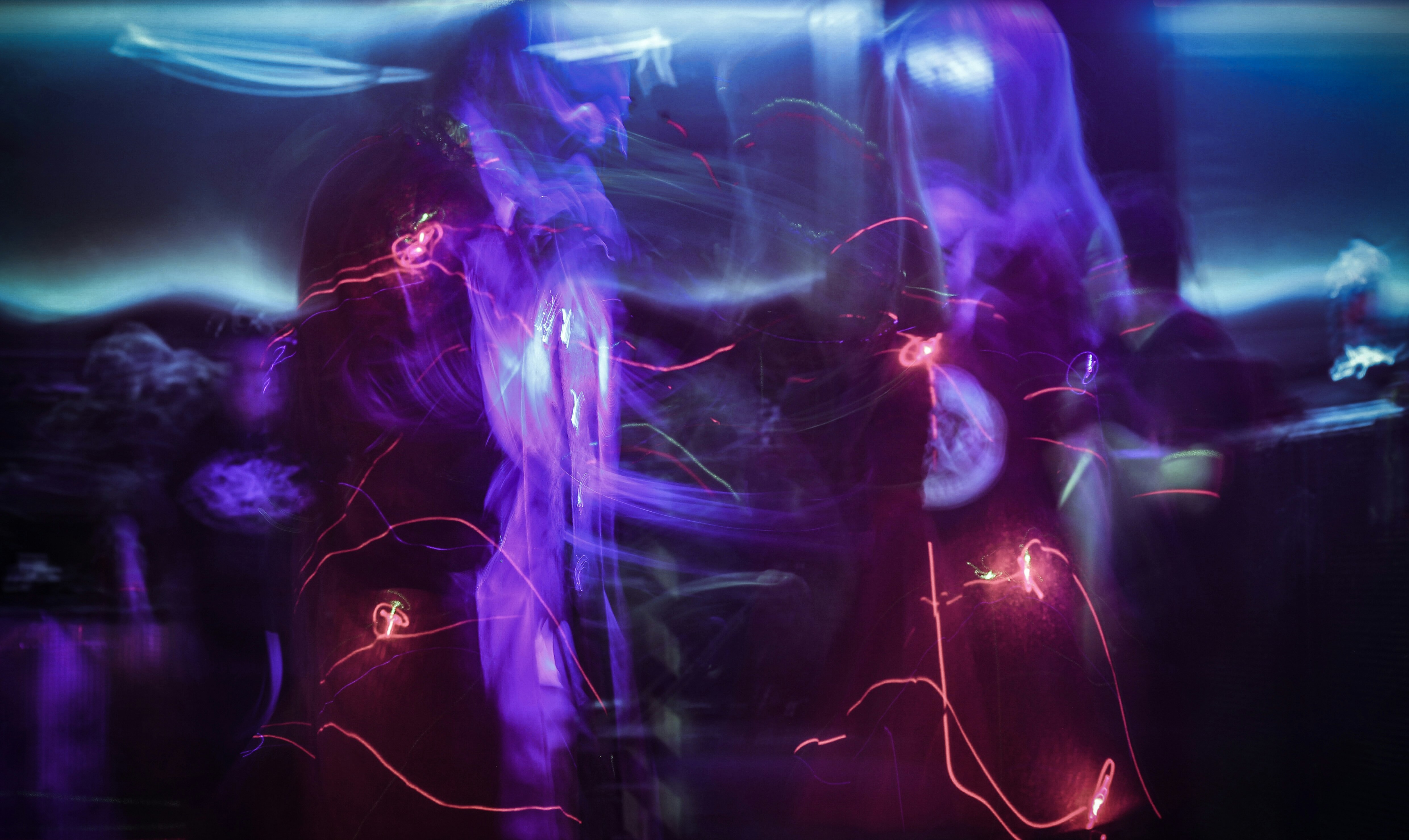 Chromatic Echoes: A Veiled Figure Under Neon Currents