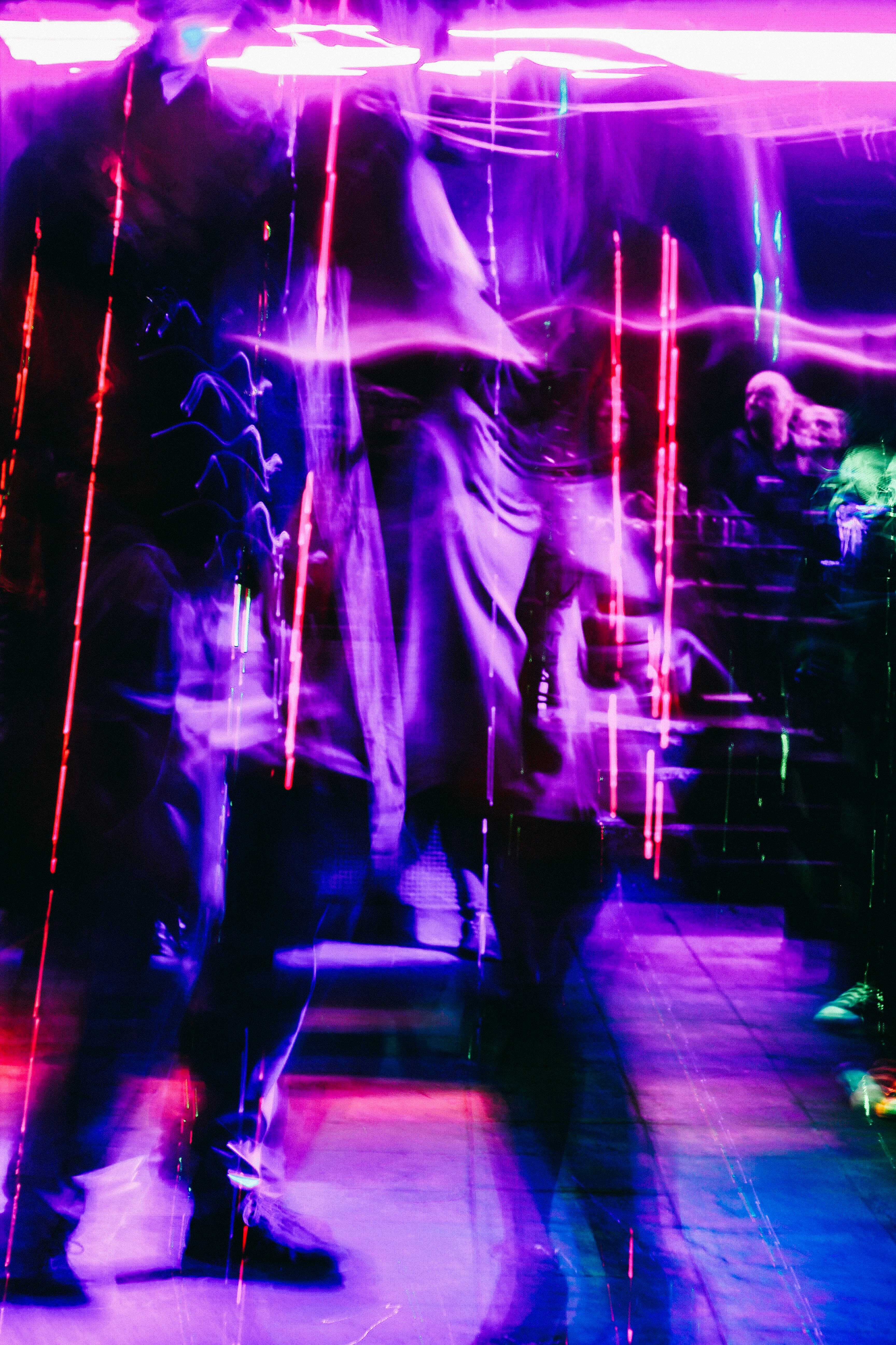 Neon Blurs: Dancers in a Prism of Light