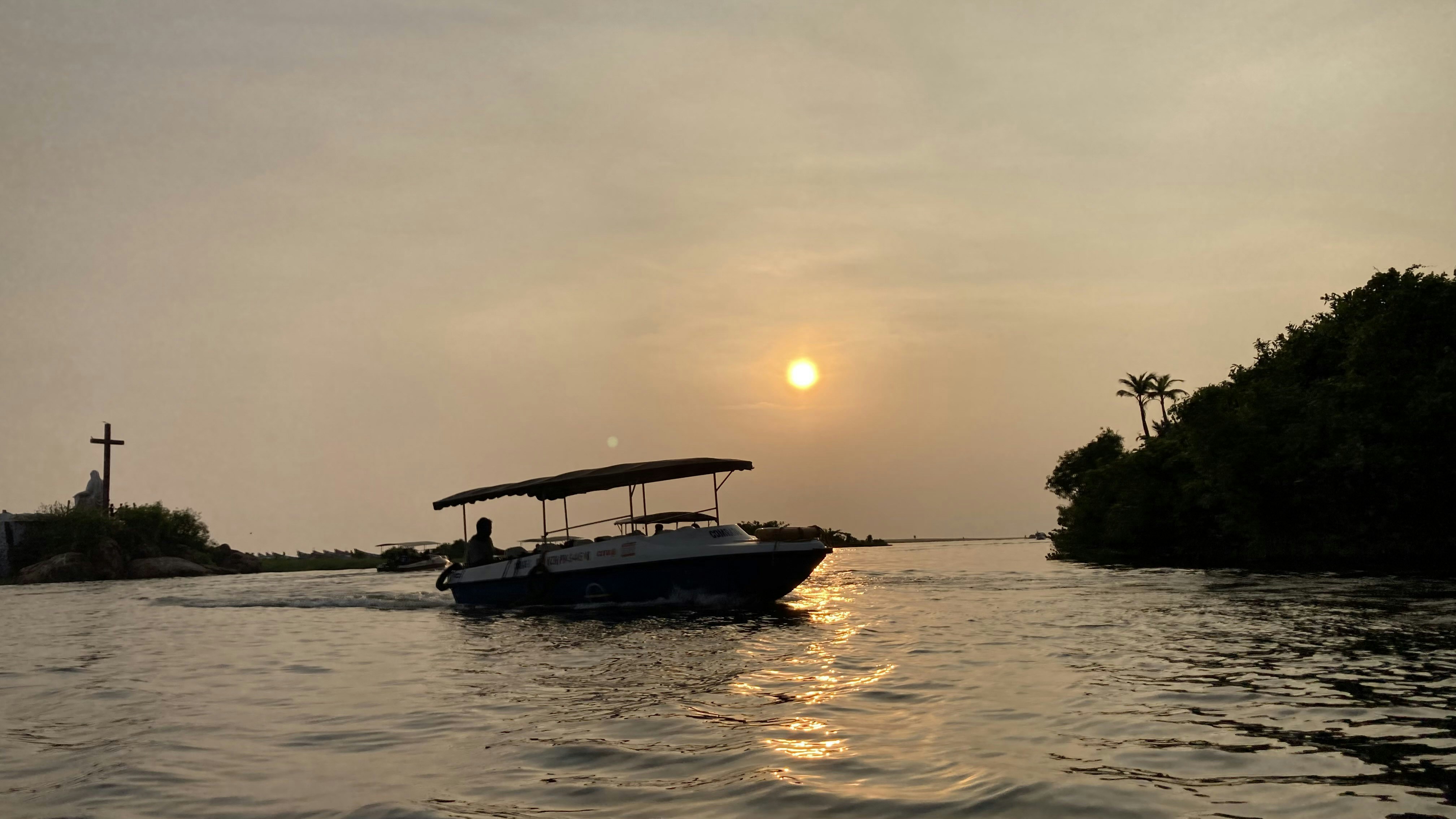 Sunlit Boat Drift: A Quiet Passage at Dusk
