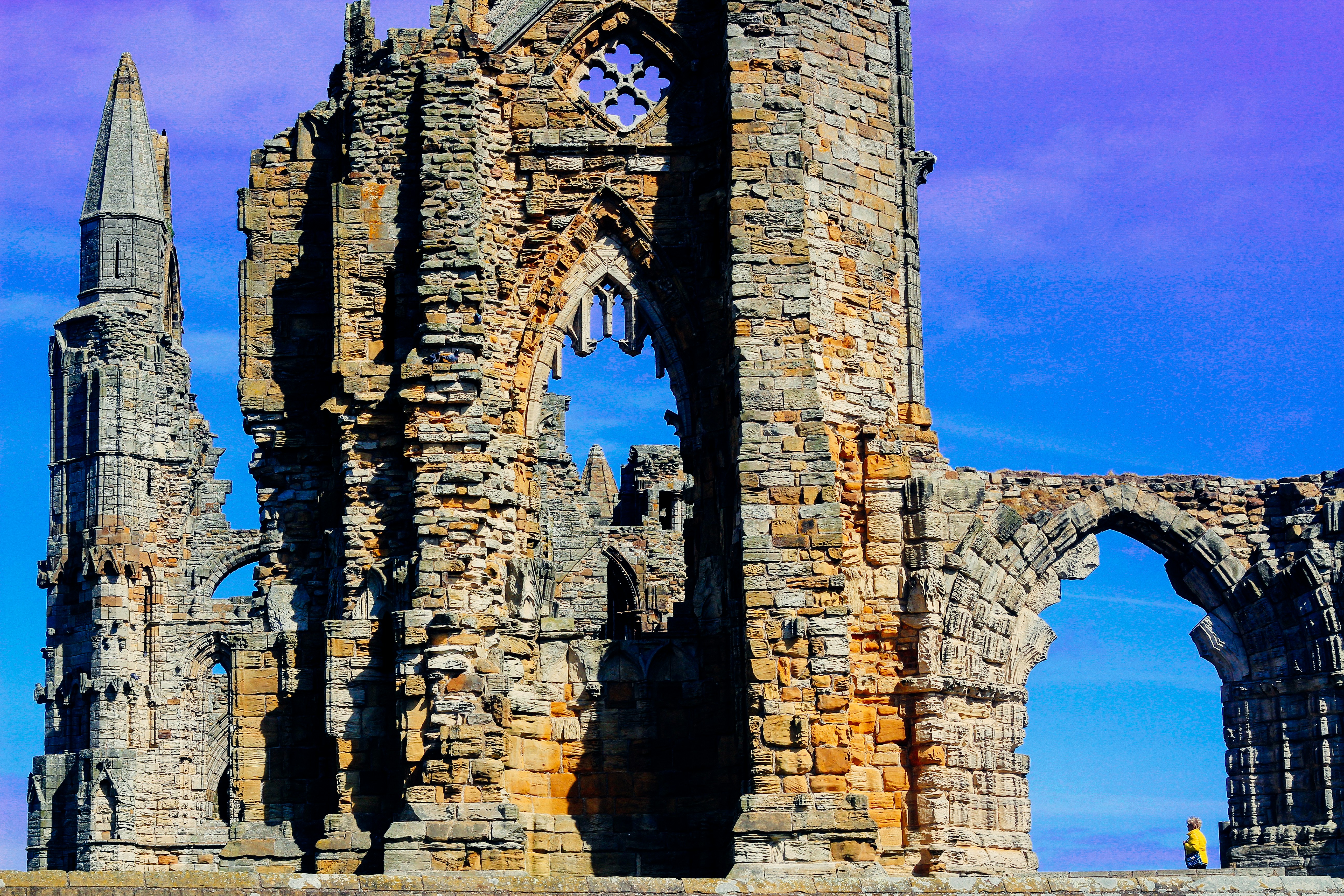 Sunlit Ruins: A Crown of Stone under a Blue Sky