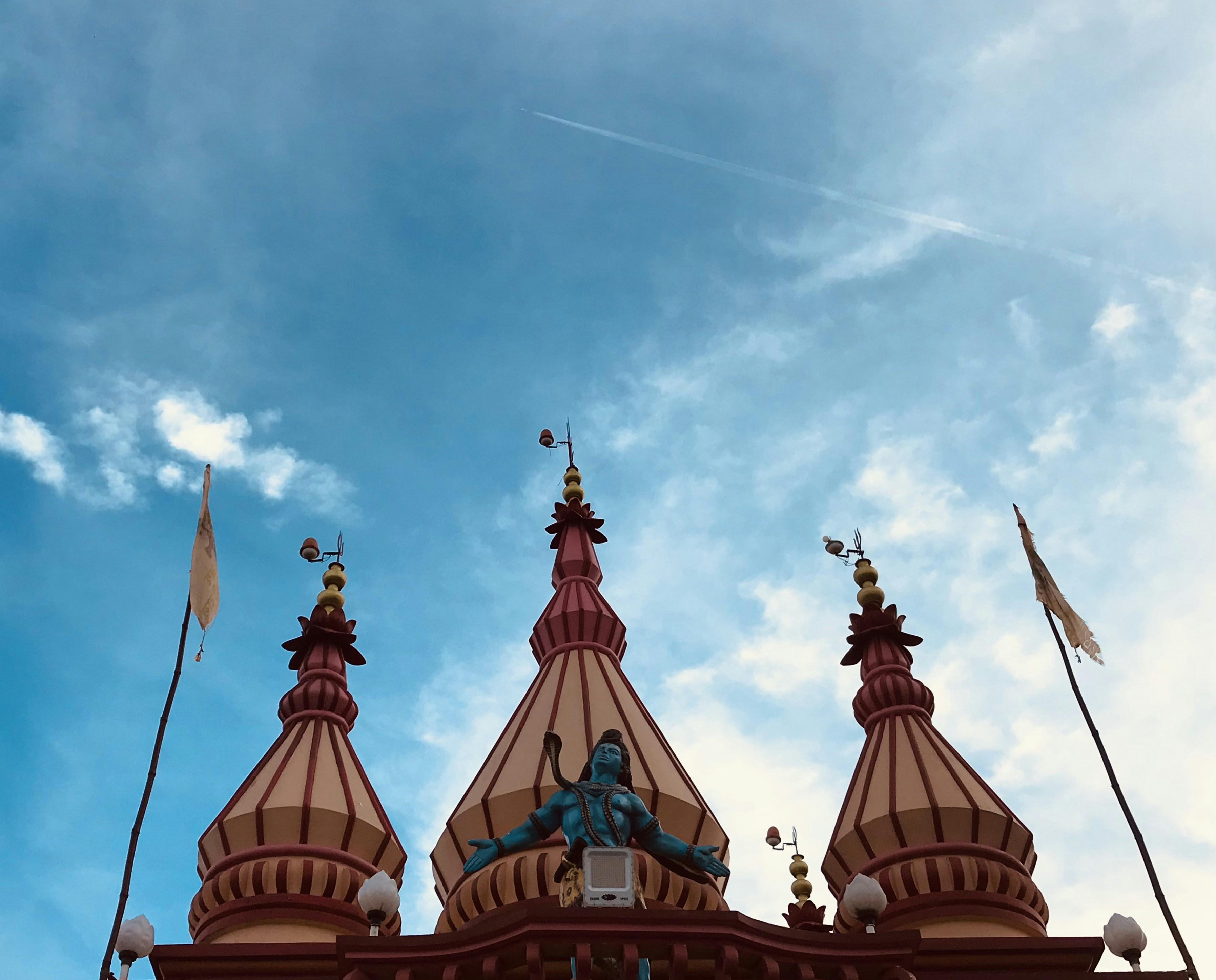 Blue Sky Over Carved Spires: A Temple Crest Against the Daylight