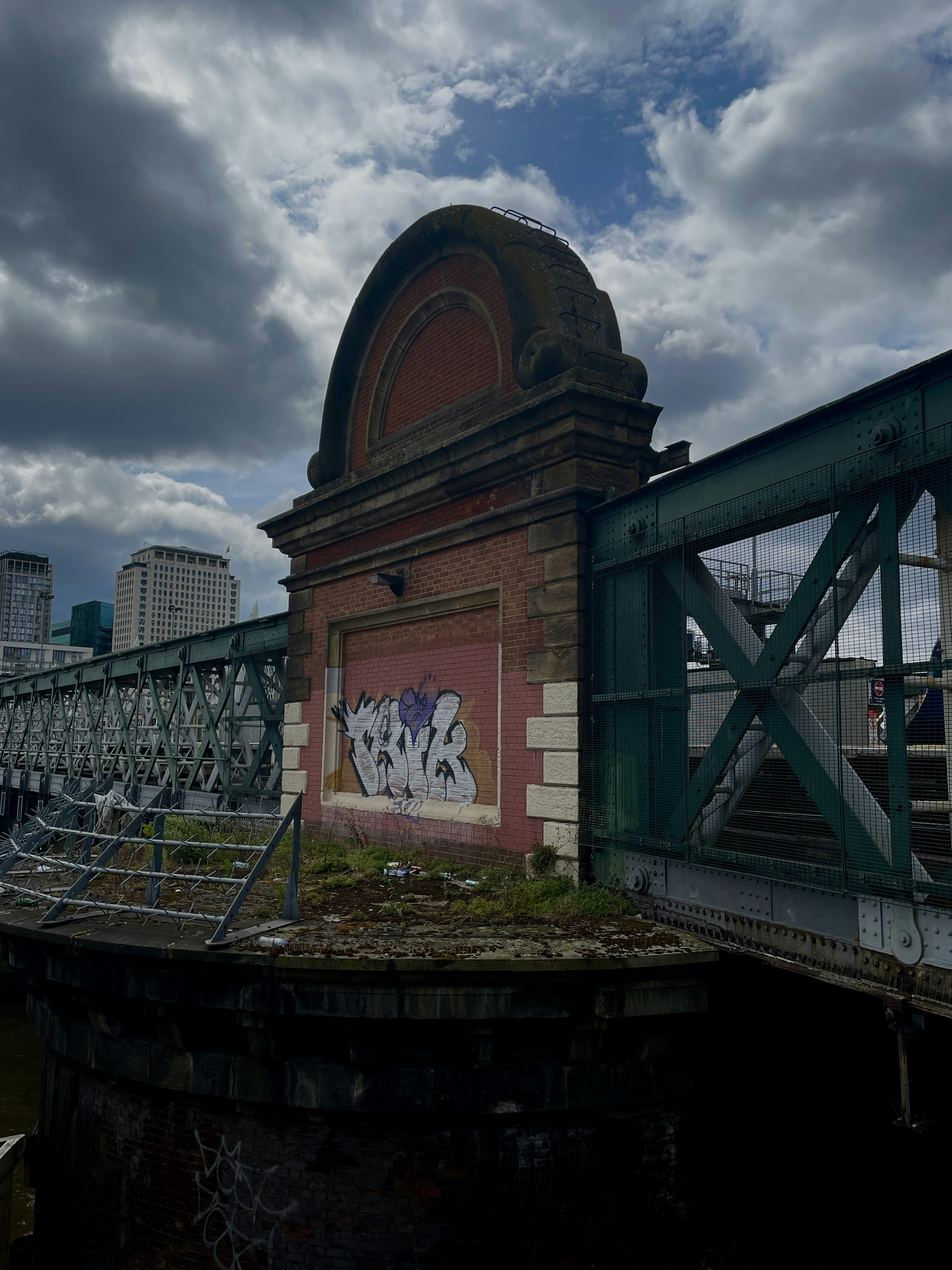 Bridge Archway Overgrown with Graffiti Centered on a Brick Structure