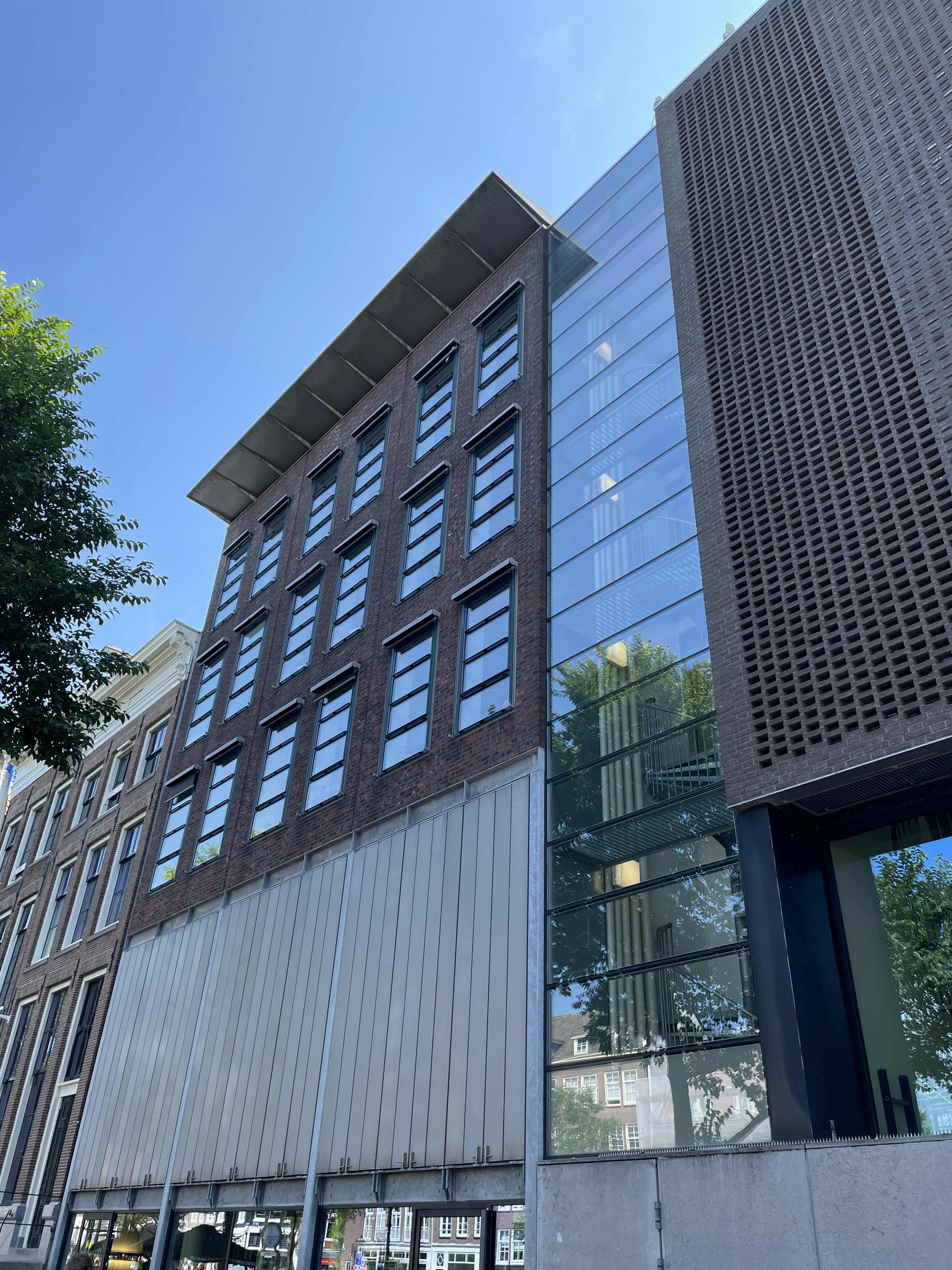 Glass-and-brick Facade: Urban Modernism Rising beside a Narrow Street