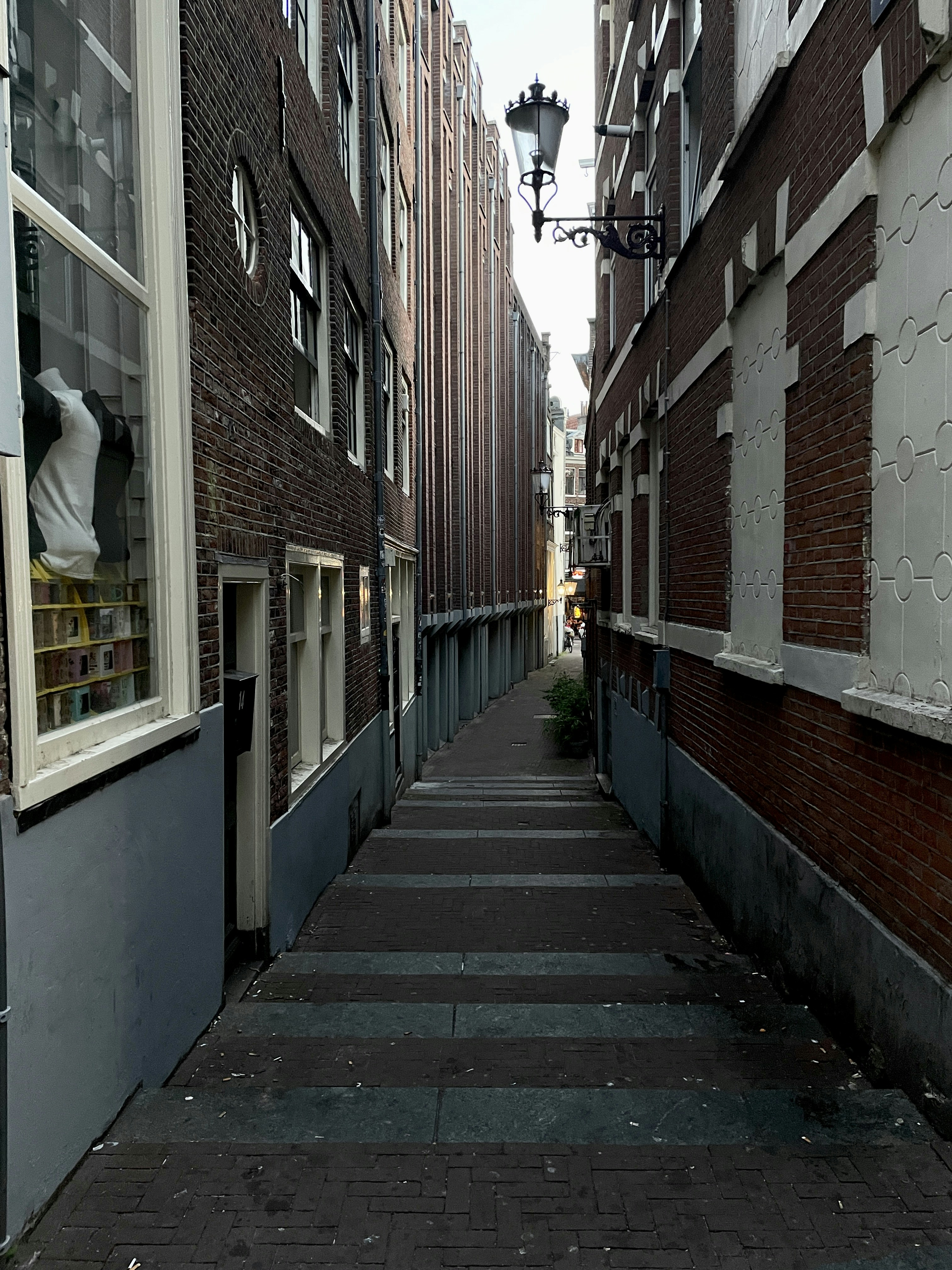 Narrow Street Lanterns: A Quiet Alley Between Brick Facades