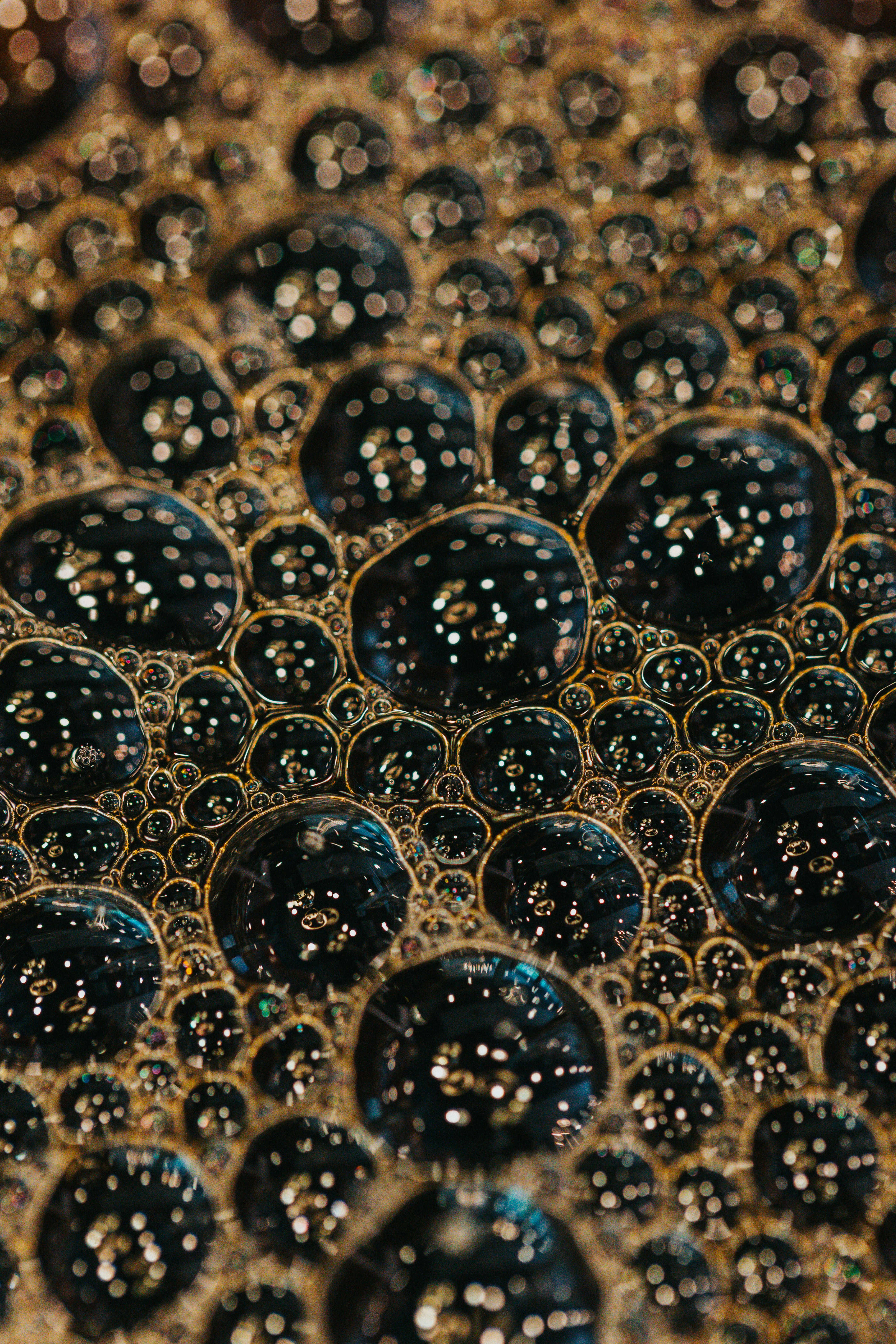 Bubble Mosaic: Tiny Orbs of Light in a Dark Golden Sea