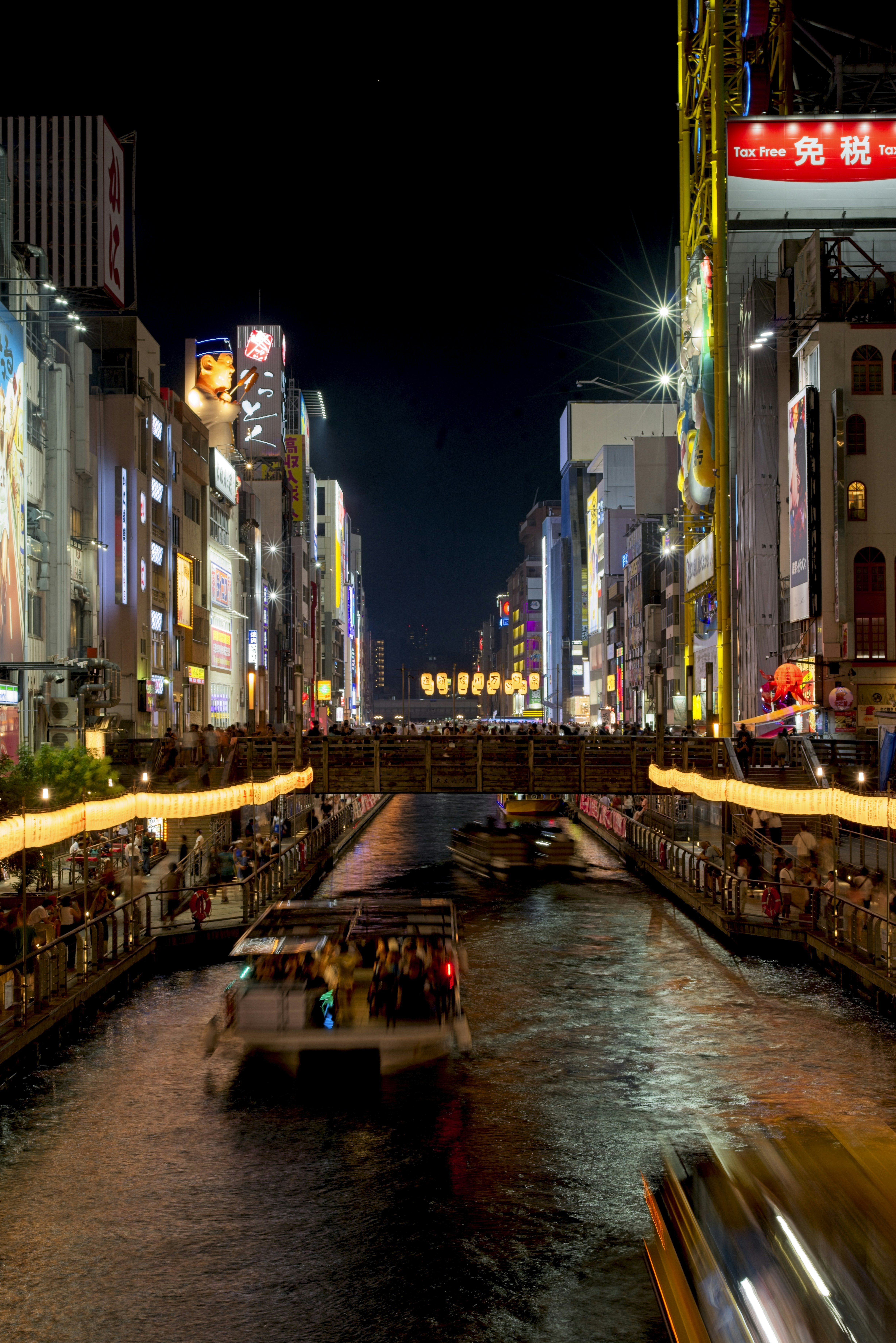 Neon Canal: Nightlife Crossing Through a City of Lights
