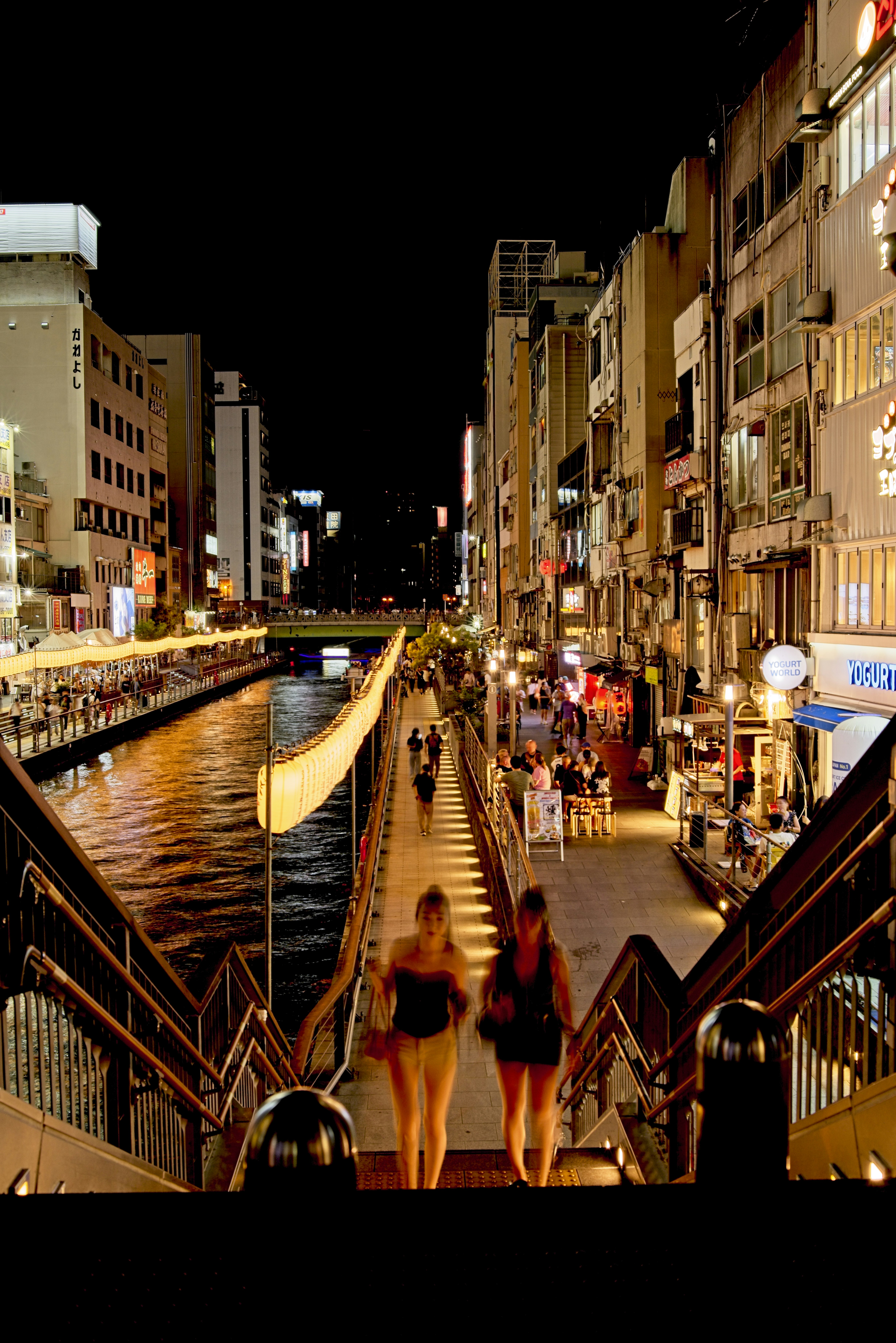 Night Riverfront Stroll: Urban Lights and Staircase Ascent