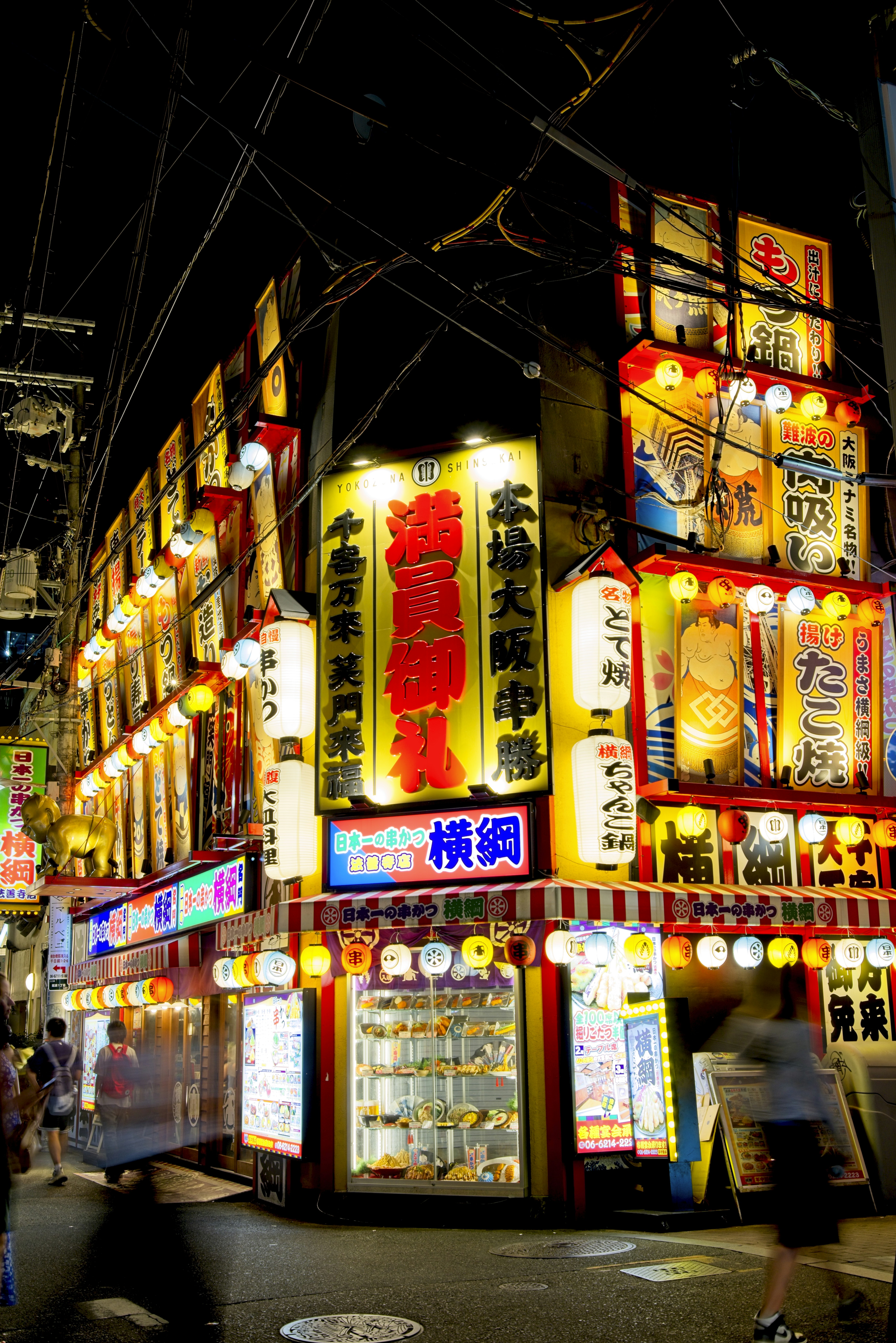 Neon Alley: A Colorful Cascade of Signs in a Bustling Osaka Street